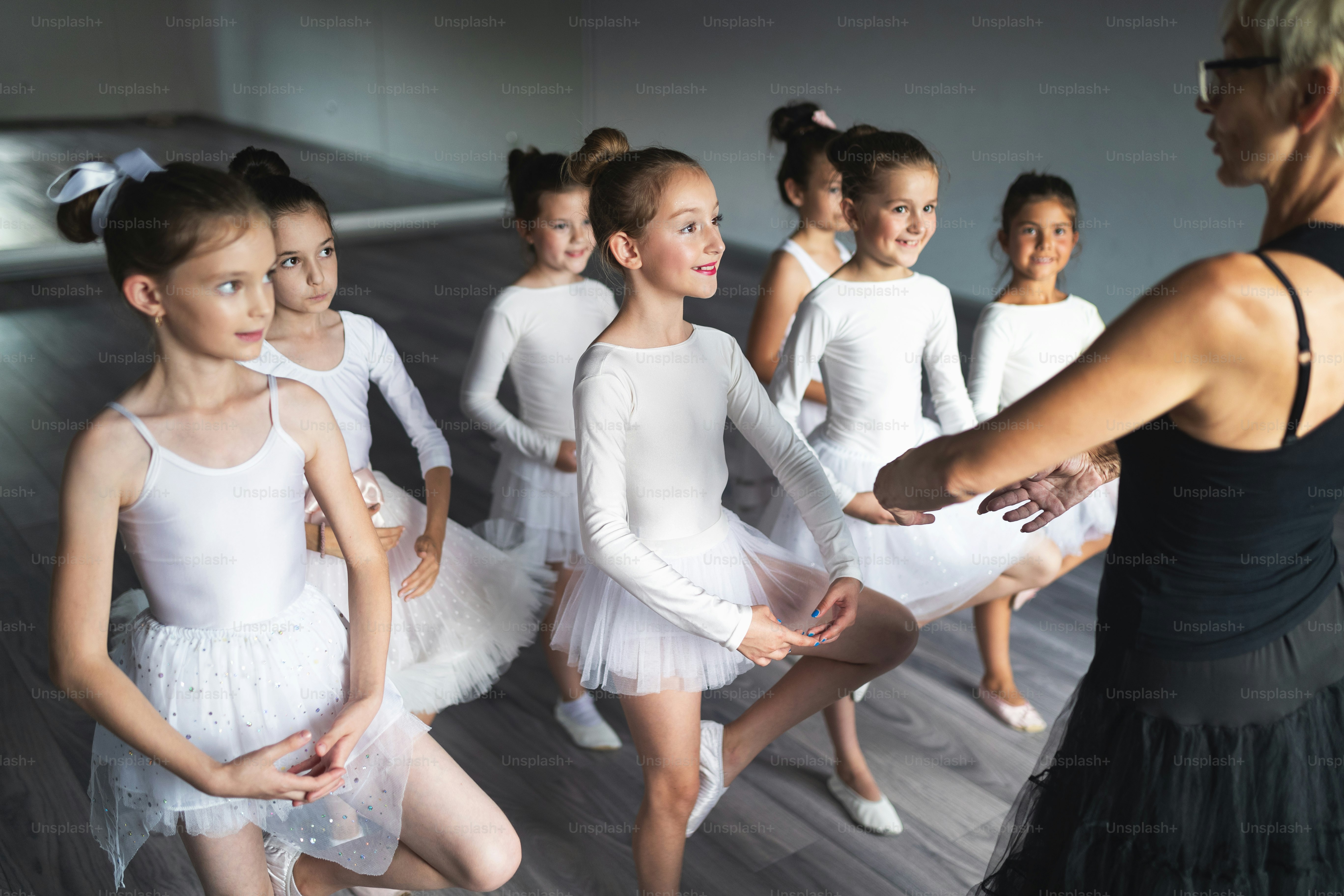 Ballet teacher and students ballerinas exercising in dance class photo ...
