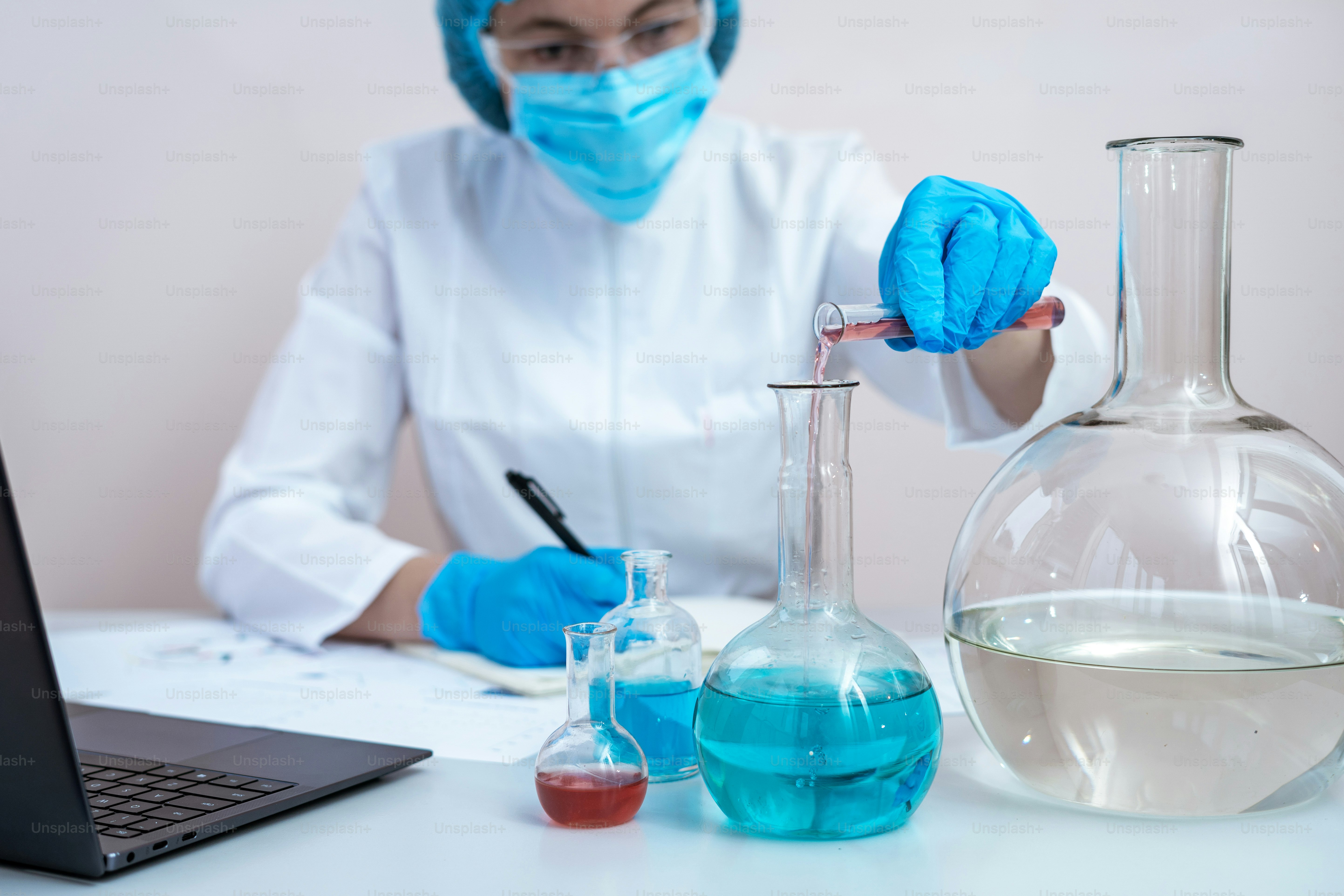 Selective focus of chemist woman in lab uniform making laboratory ...