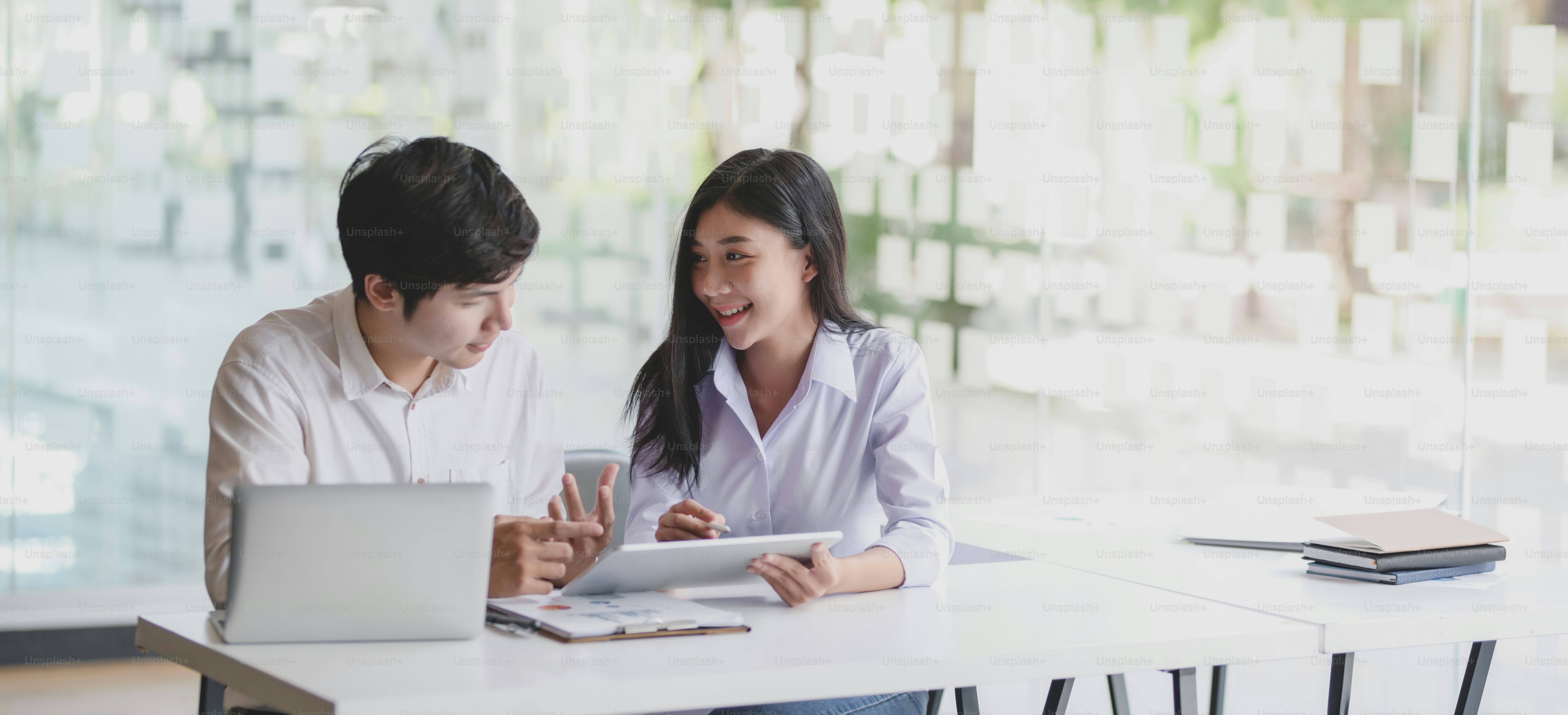Two professional business partner discussing their project together in ...