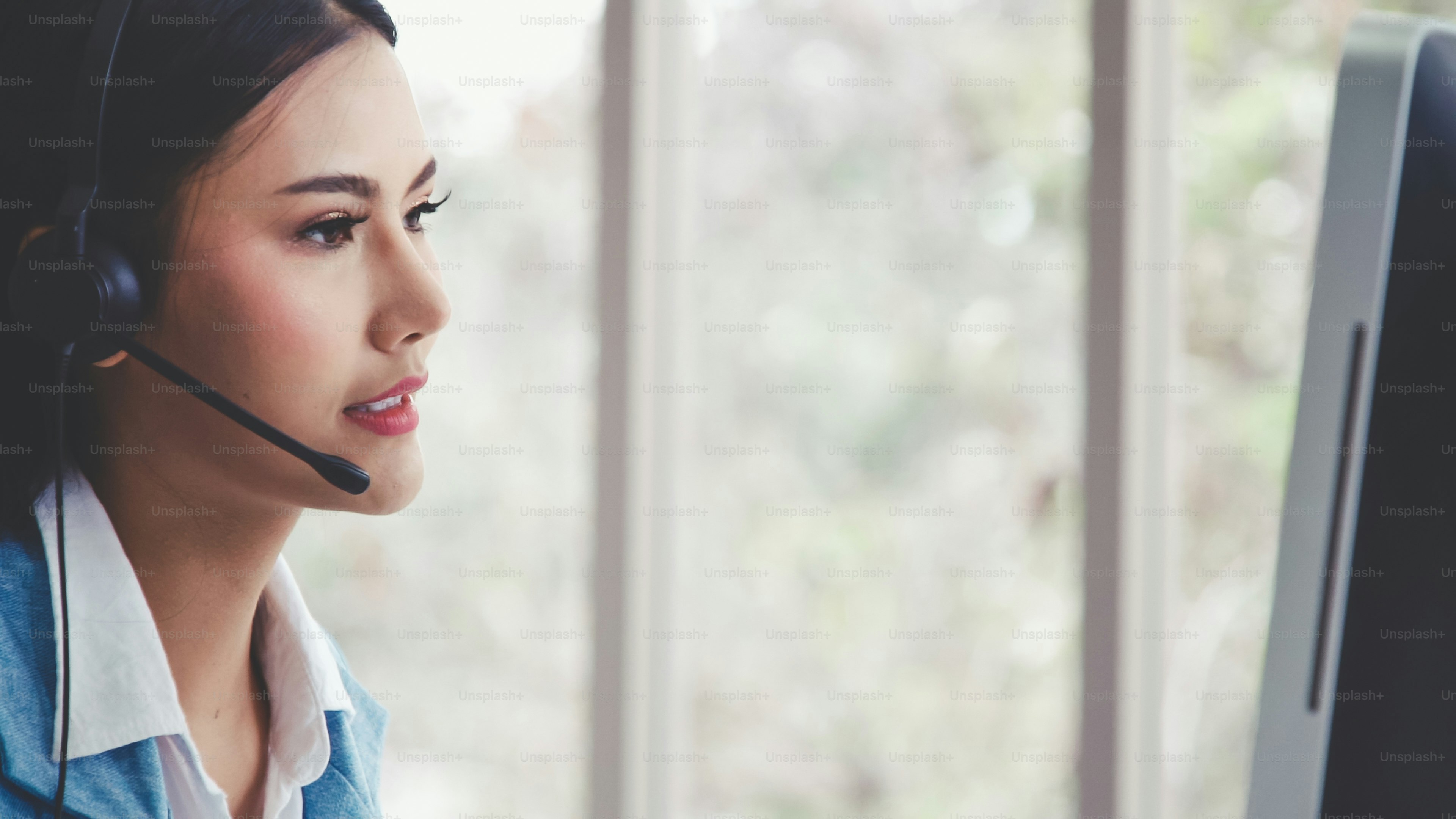 Customer support agent or call center with headset works on desktop ...