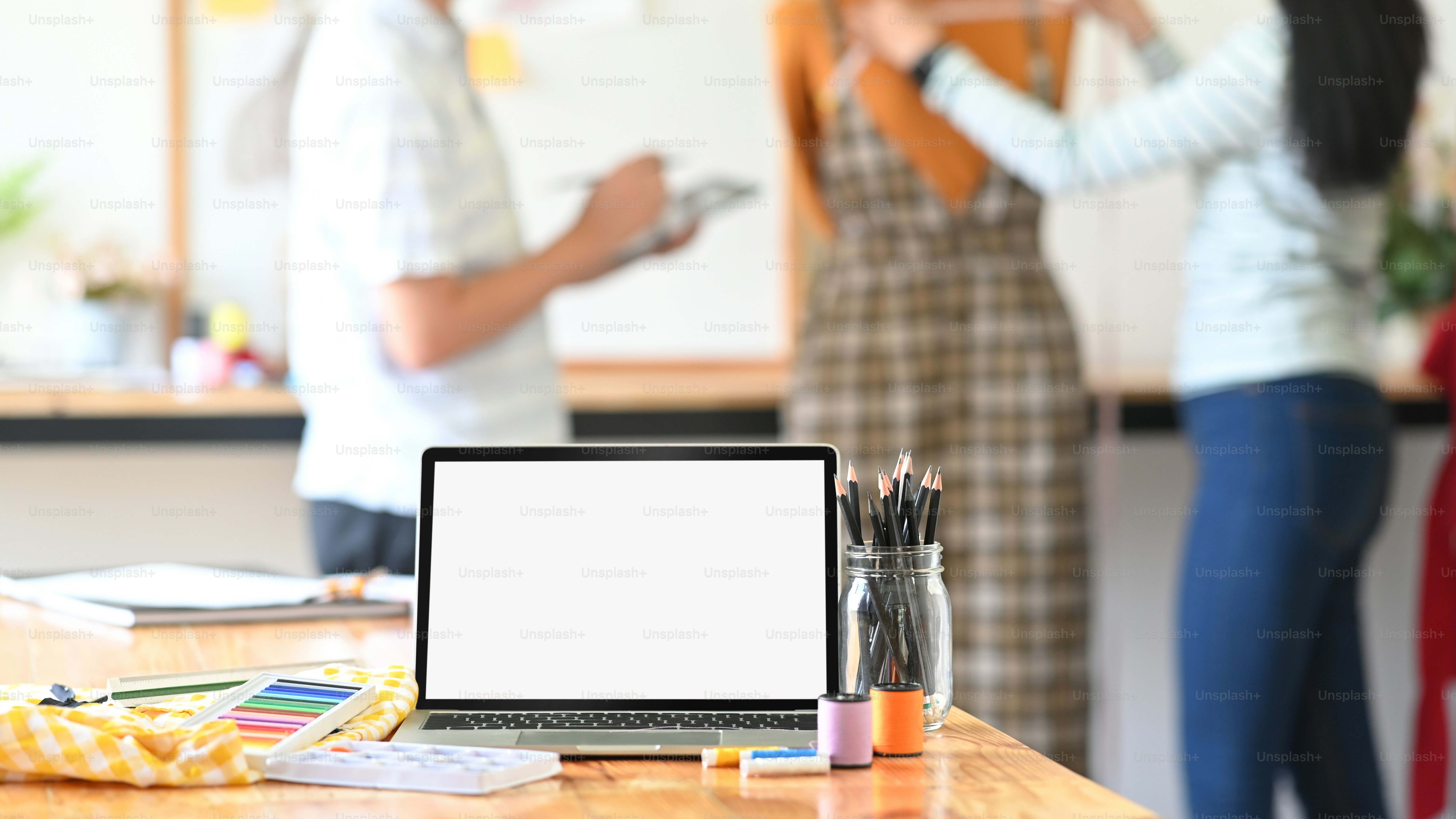 Laptop computer with blank screen on fashion designer Tailor workspace ...