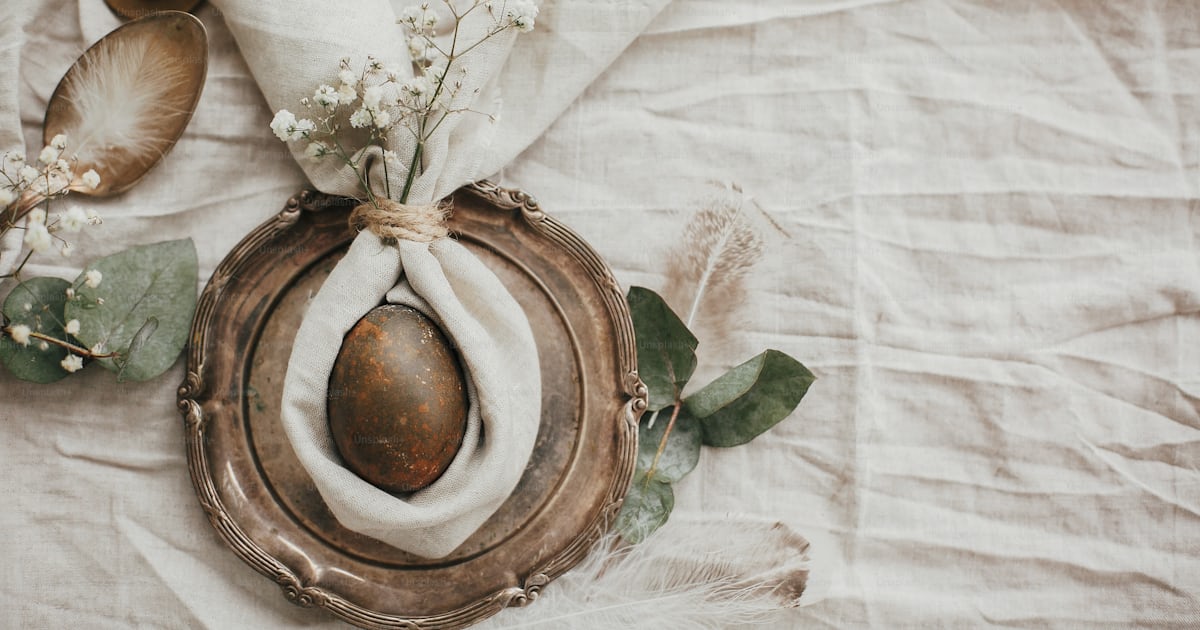 Stylish Easter brunch table setting with egg in easter bunny napkin ... Stylish Easter brunch table setting with egg in easter bunny napkin ...