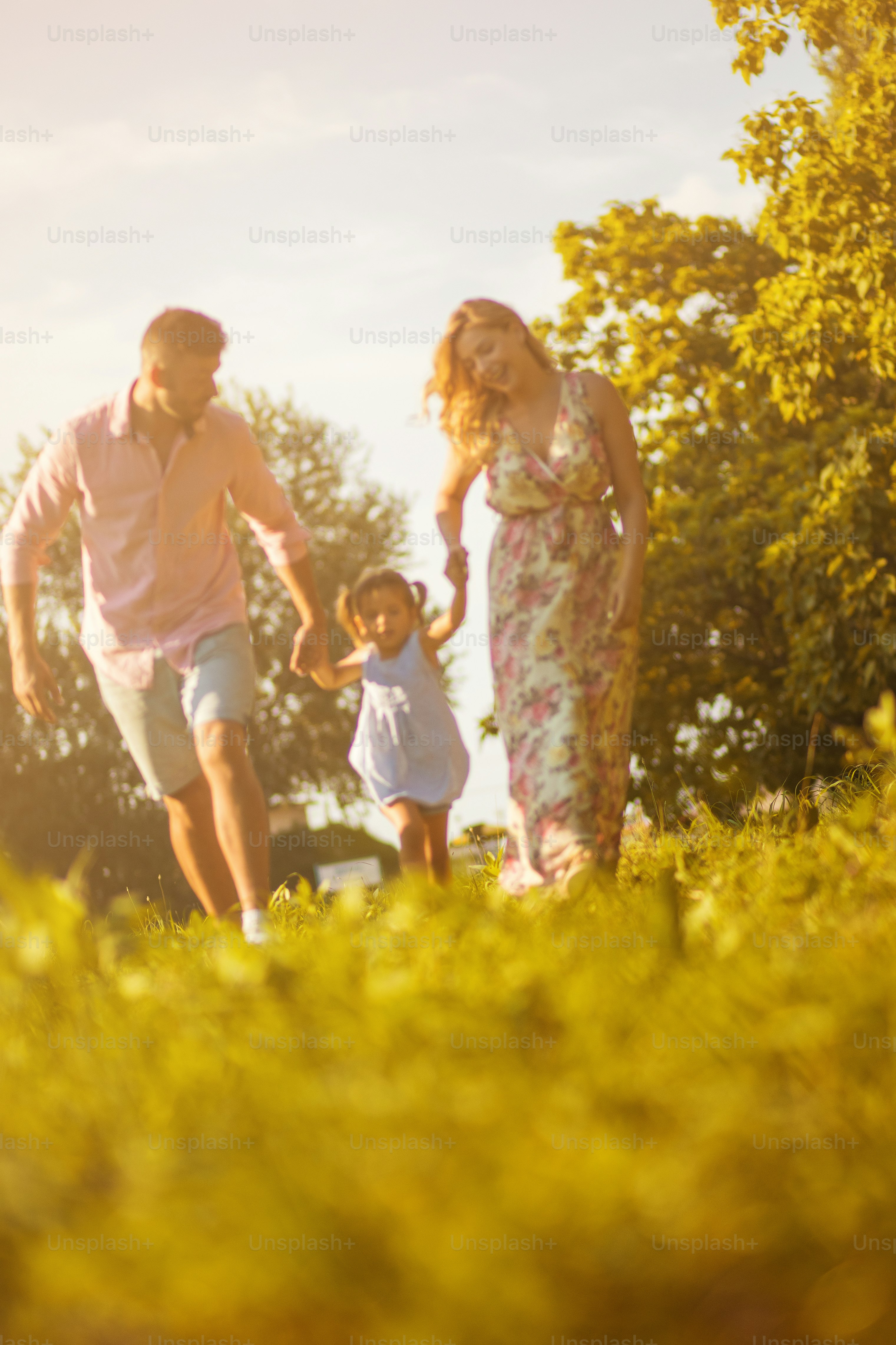 The lovely smile of a happy little girl. Parents with daughter having ...