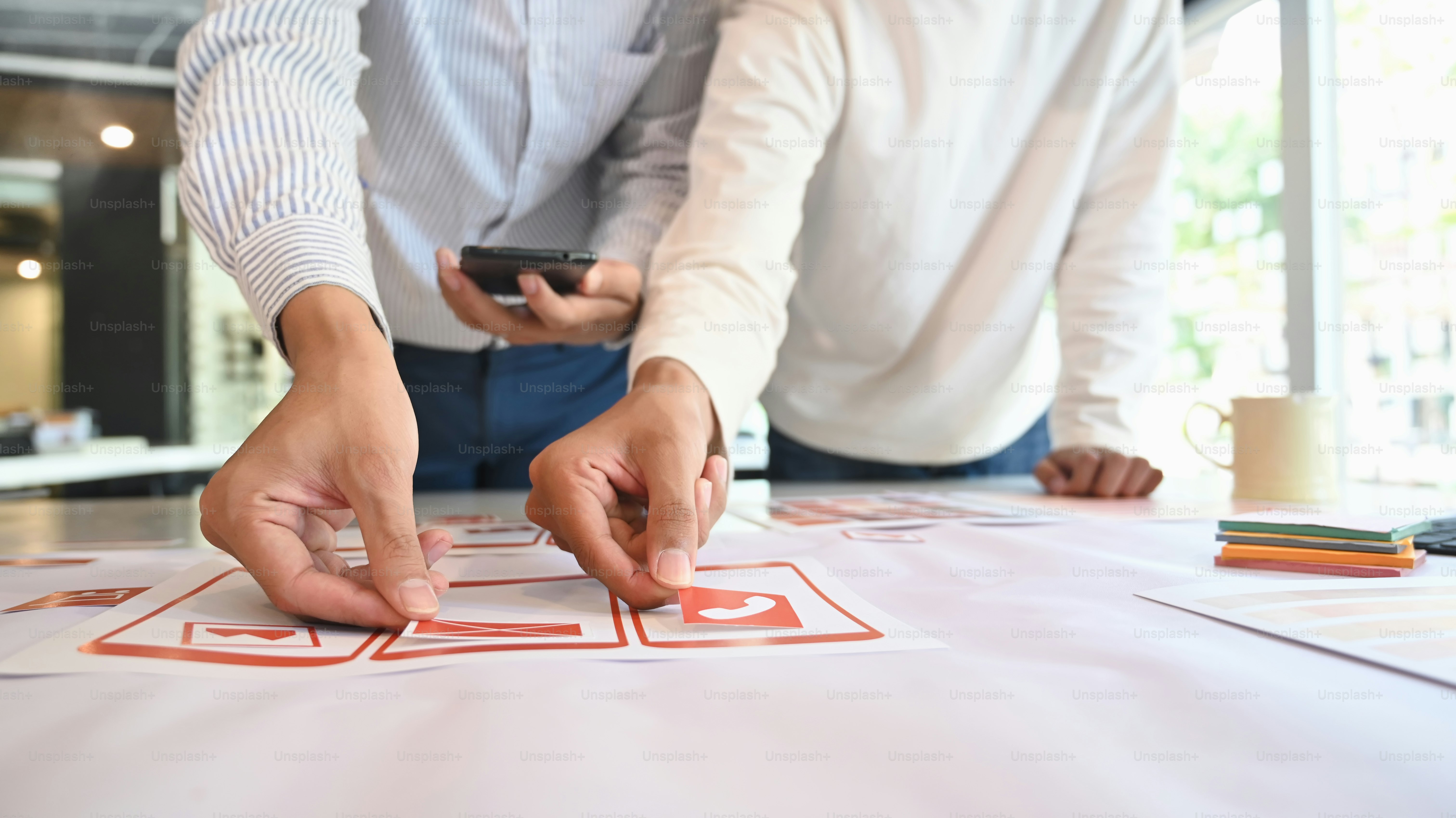 App developer Ux Ui designing with paper model on mobile application ...