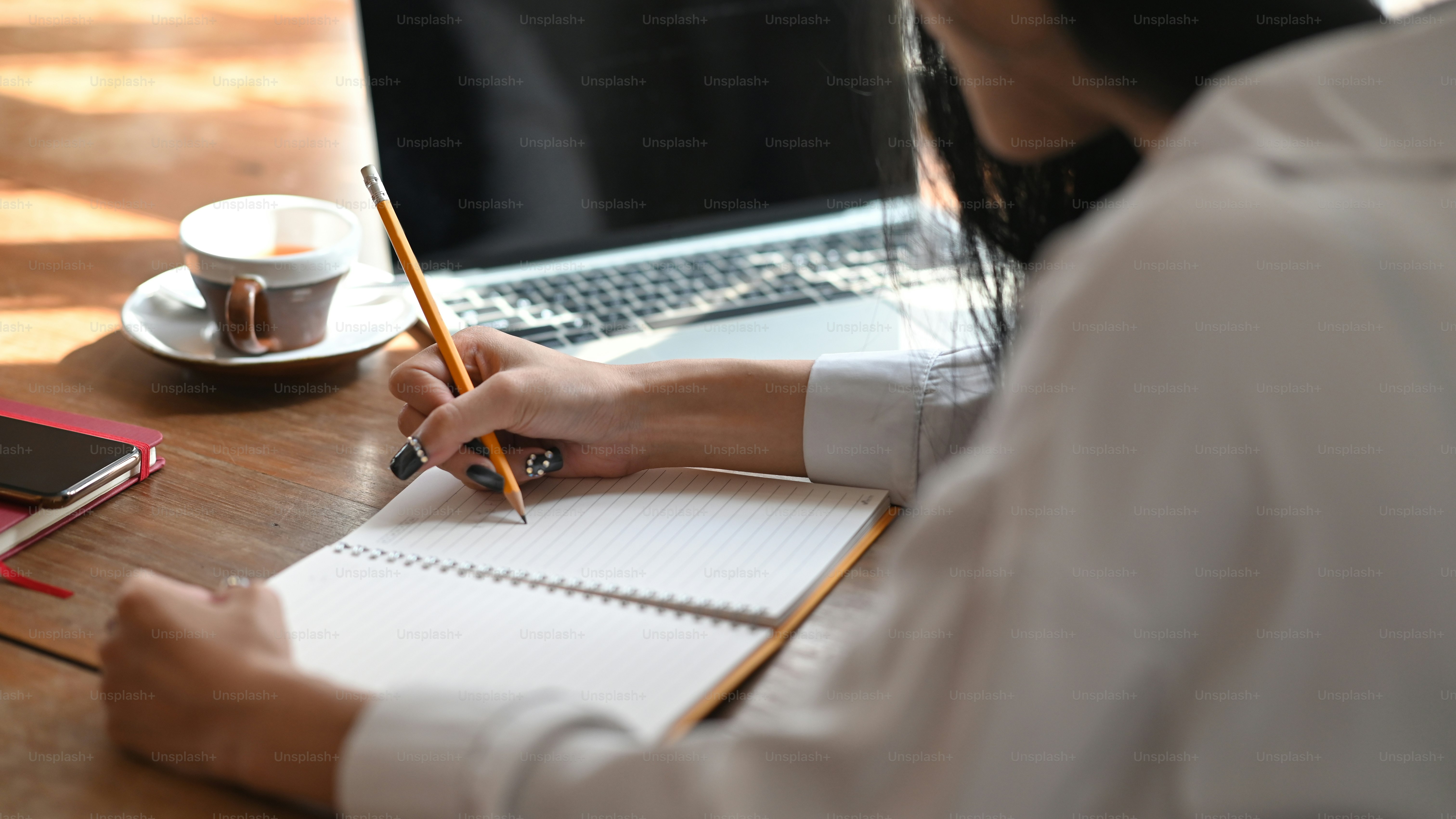 Closeup woman writing on notepad paper on wooden table. photo – Free ...