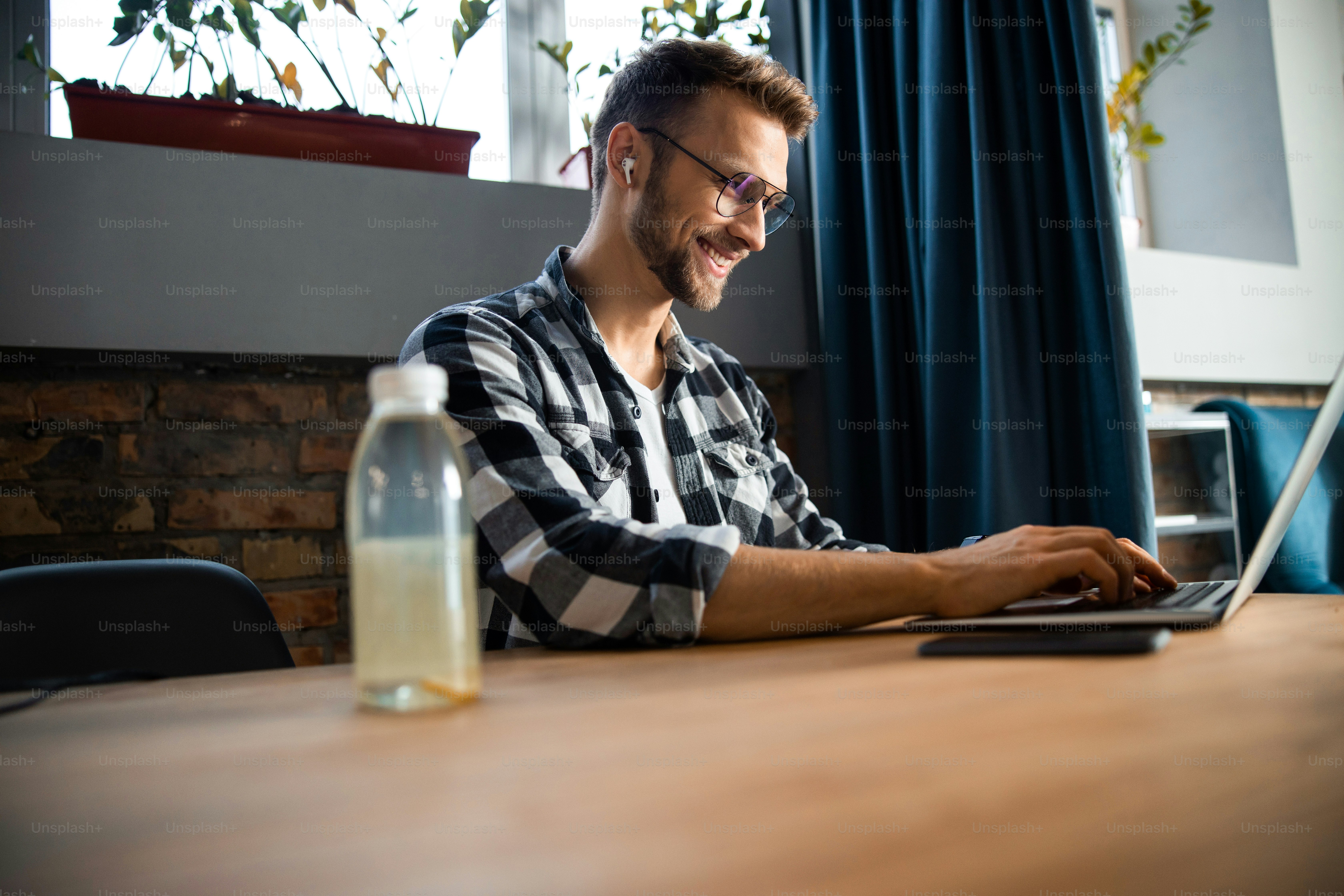 Handsome guy working on laptop while enjoying time in cafe stock photo ...
