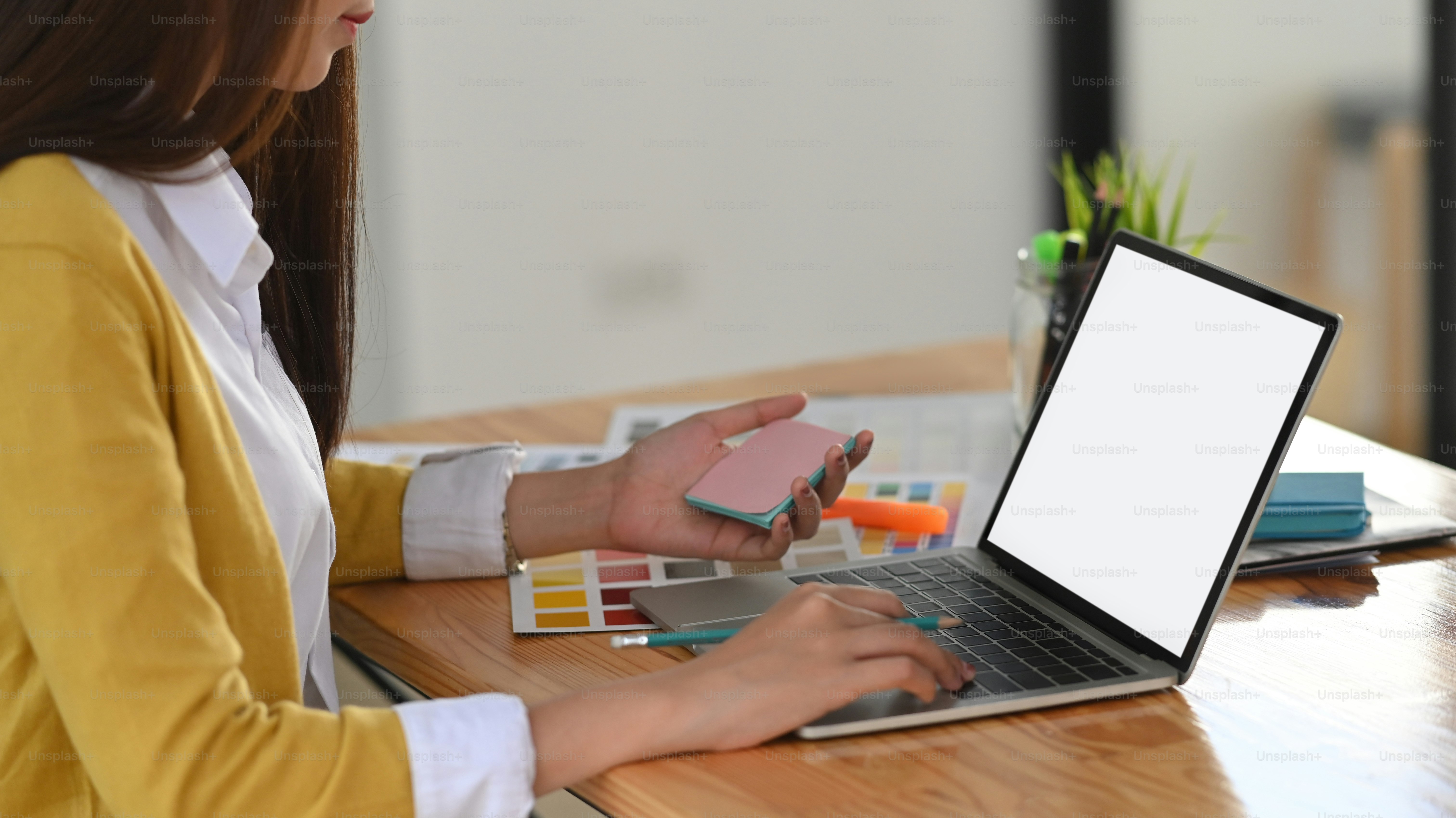Cropped shot of young beautiful designer typing on keyboard and holding ...