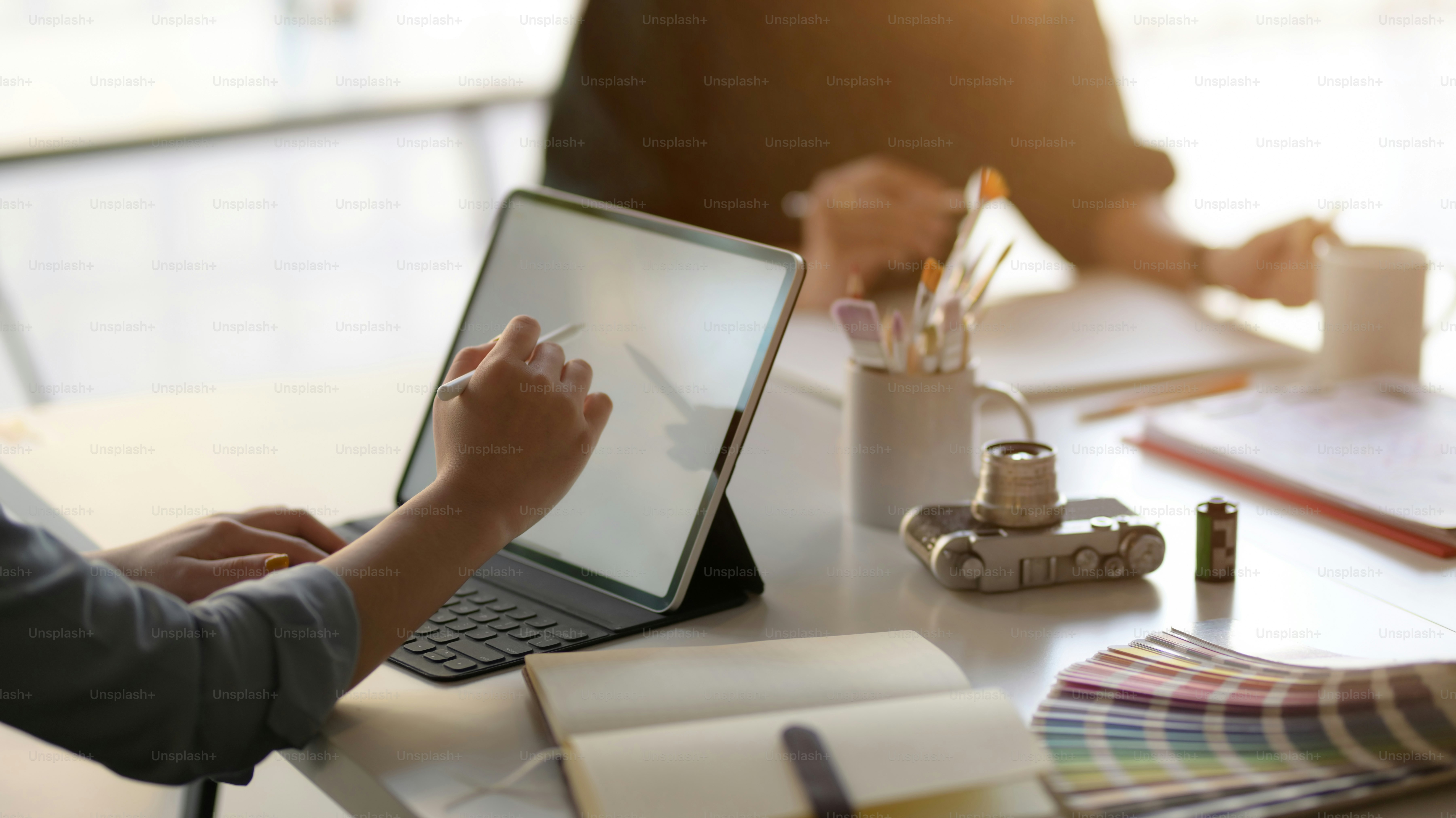 Close up view of female app developer drawing on mock up tablet while ...