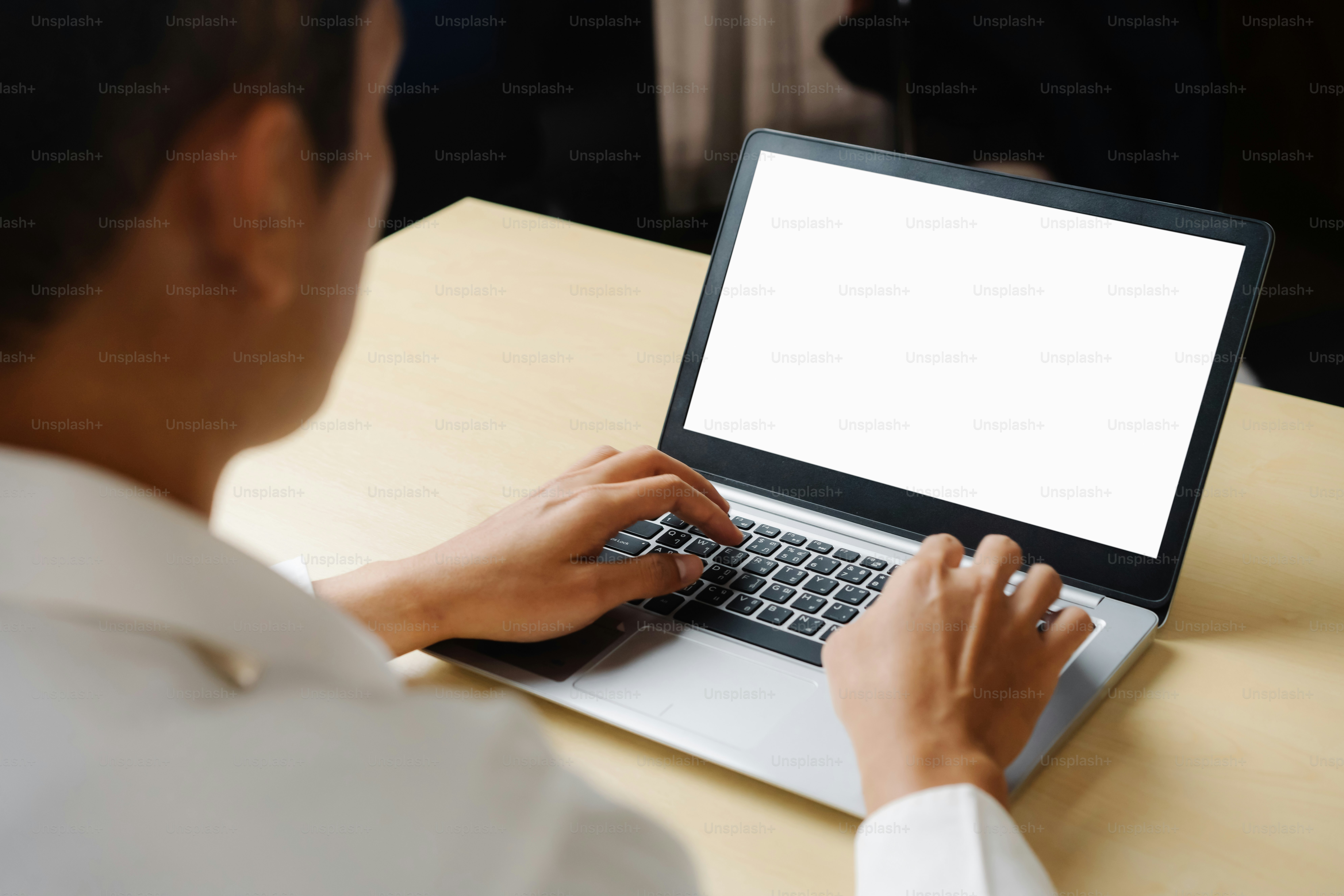 Business person or office worker using laptop computer while sitting at ...