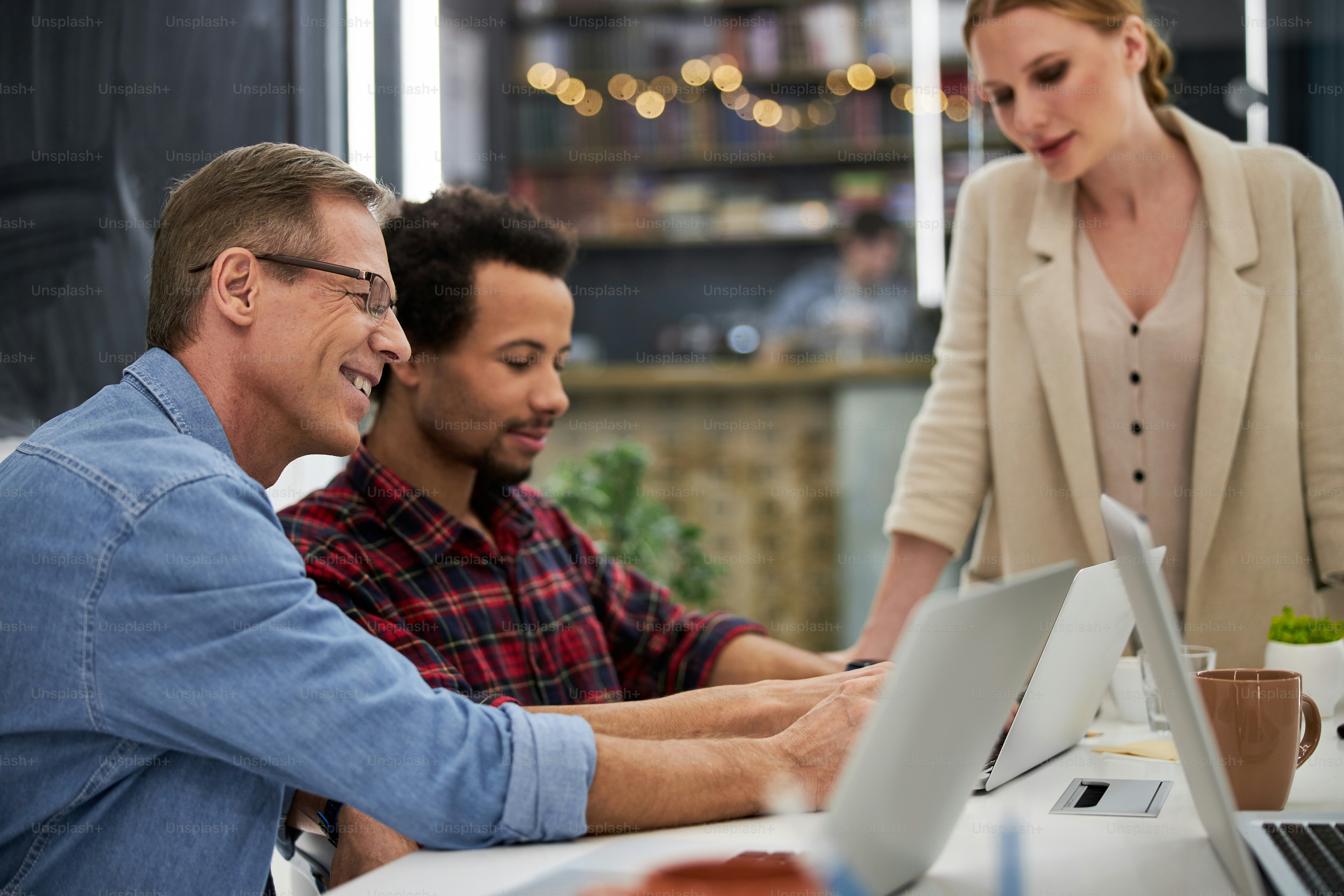 Creative team using laptop in modern office stock photo photo ...
