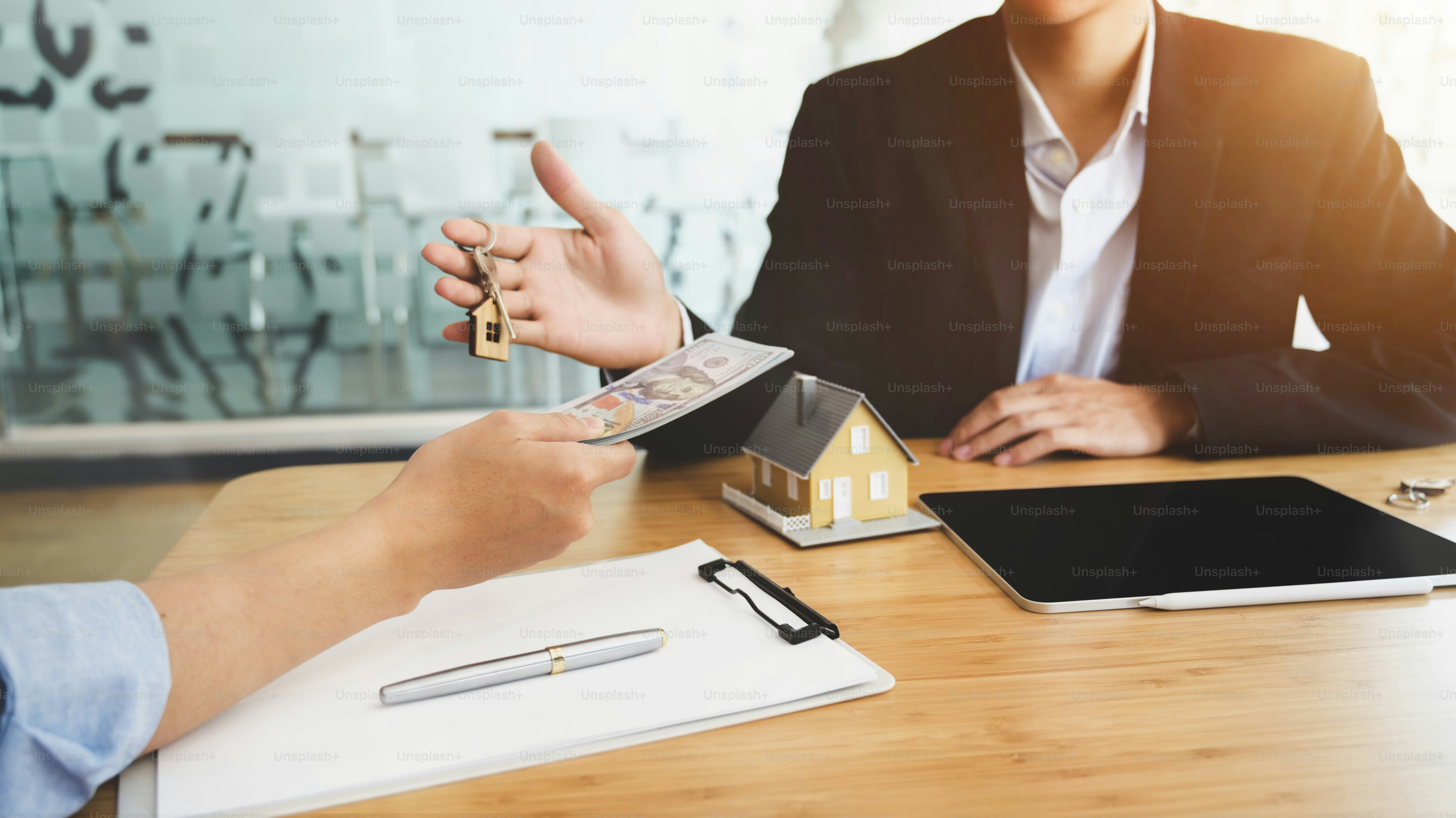 Cropped shot of real estate agent giving house key to his customer ...