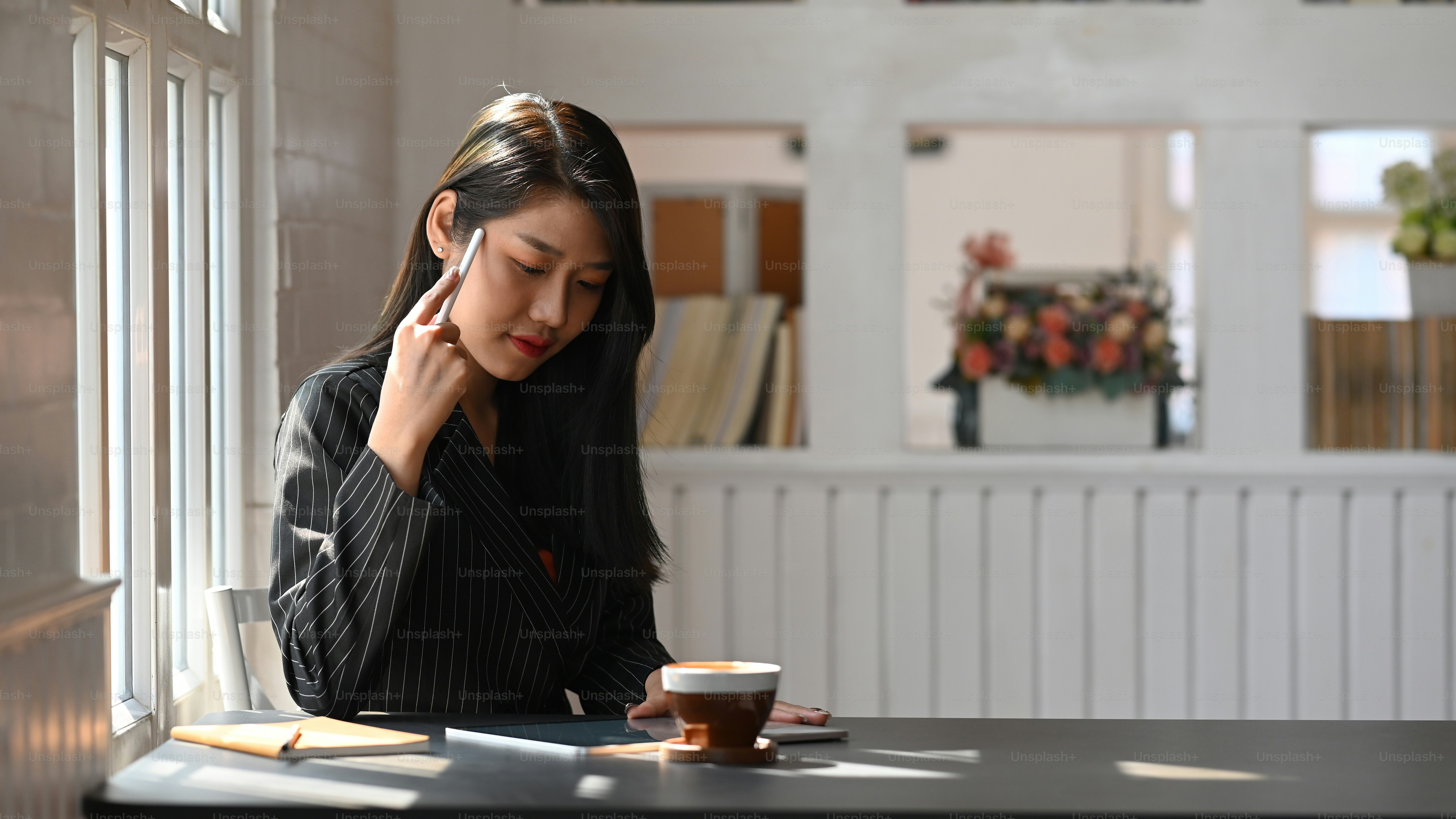 Photo of young beautiful executive woman planning/contemplating about ...