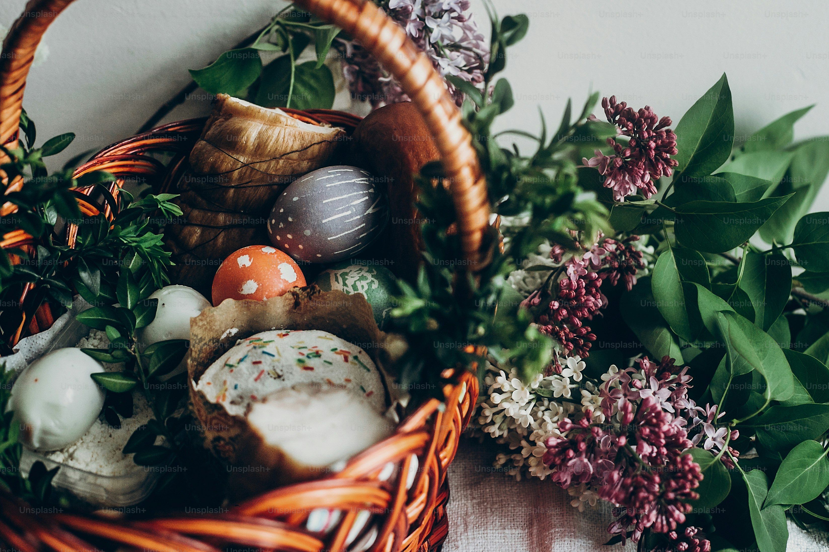 Easter basket with cake and eggs ham food. colorful decorated egg with ...