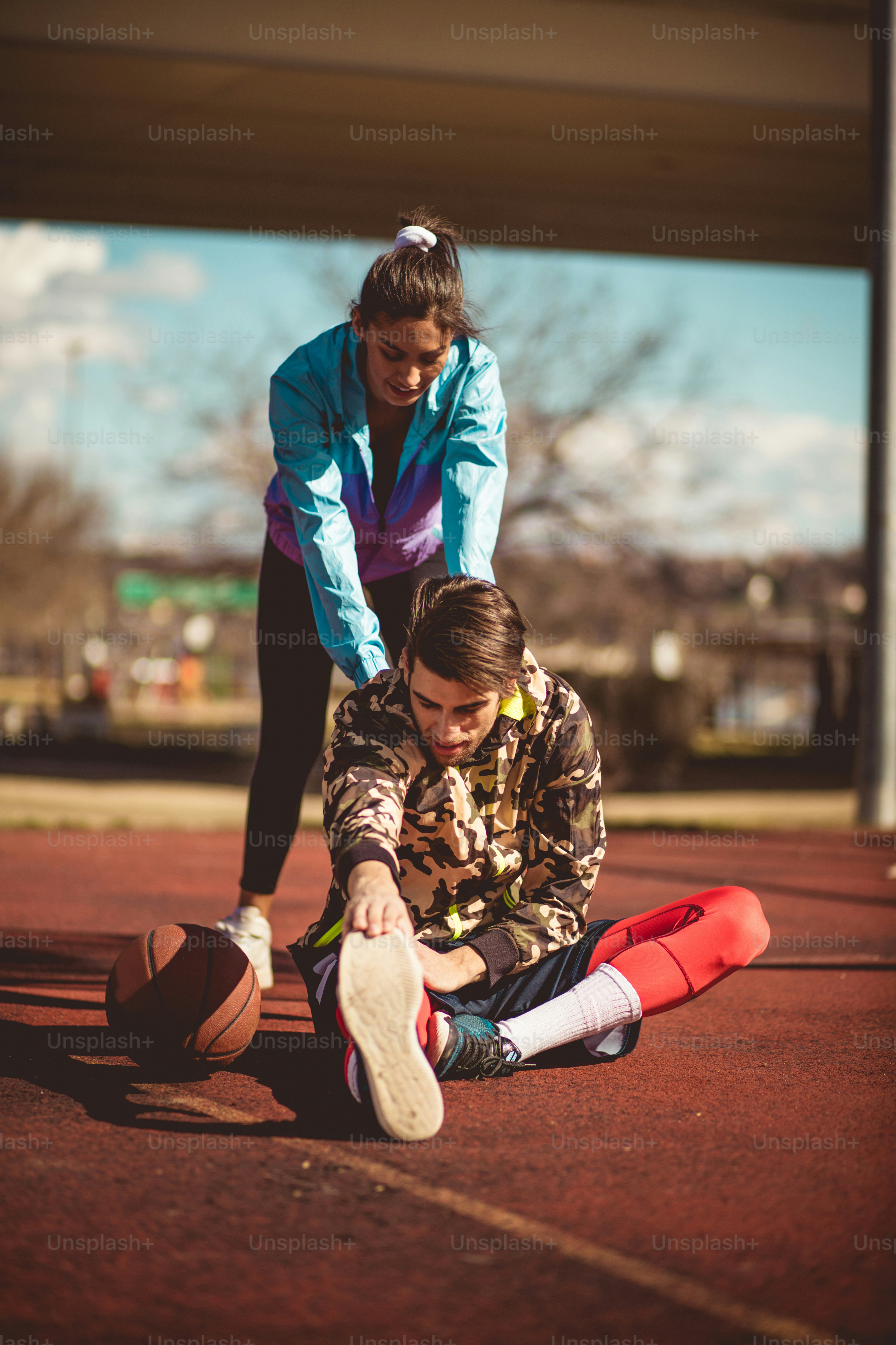 Injuries during the game. Young couple on basketball court. photo ...