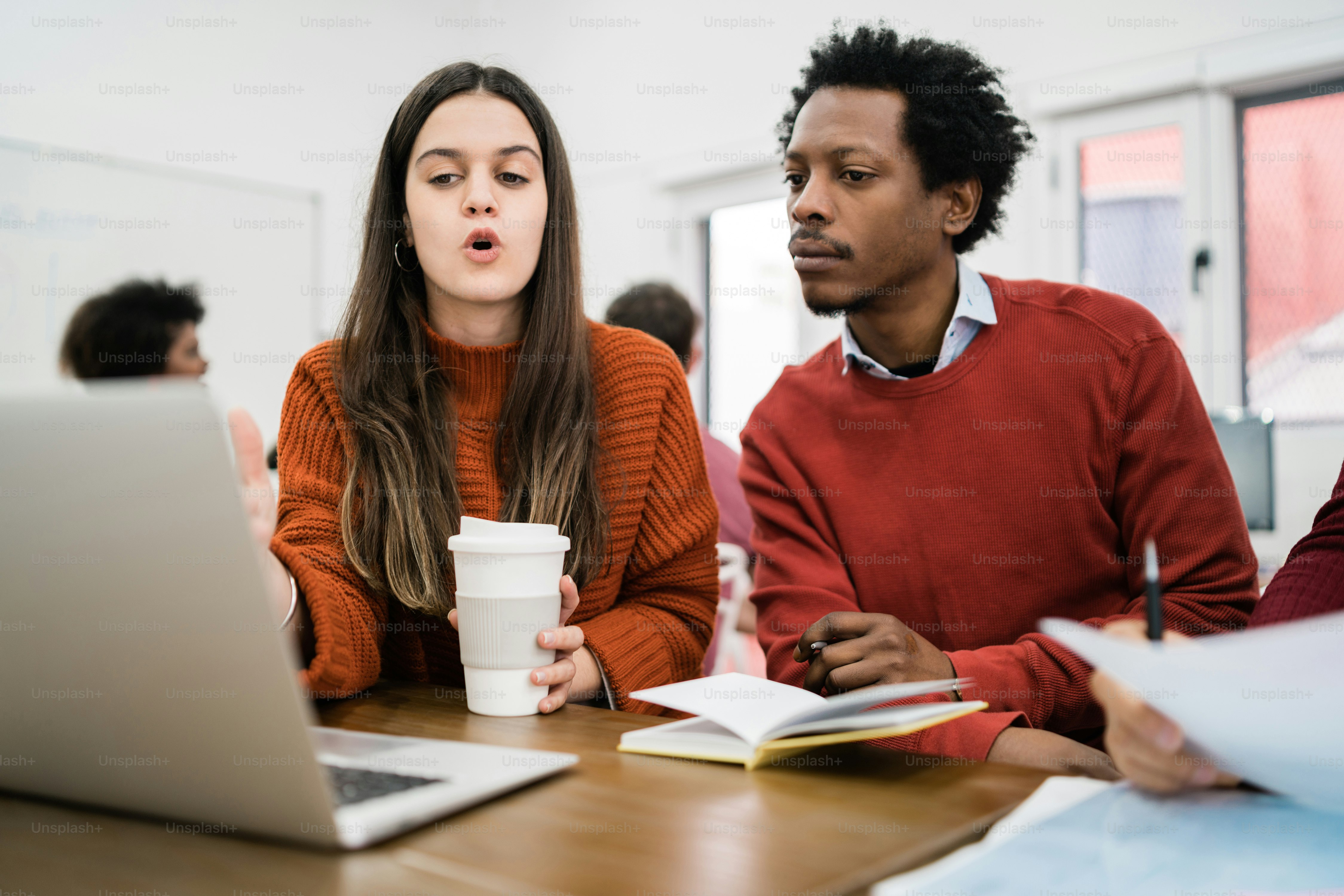 Two creative designers working in a project together and sharing new ...