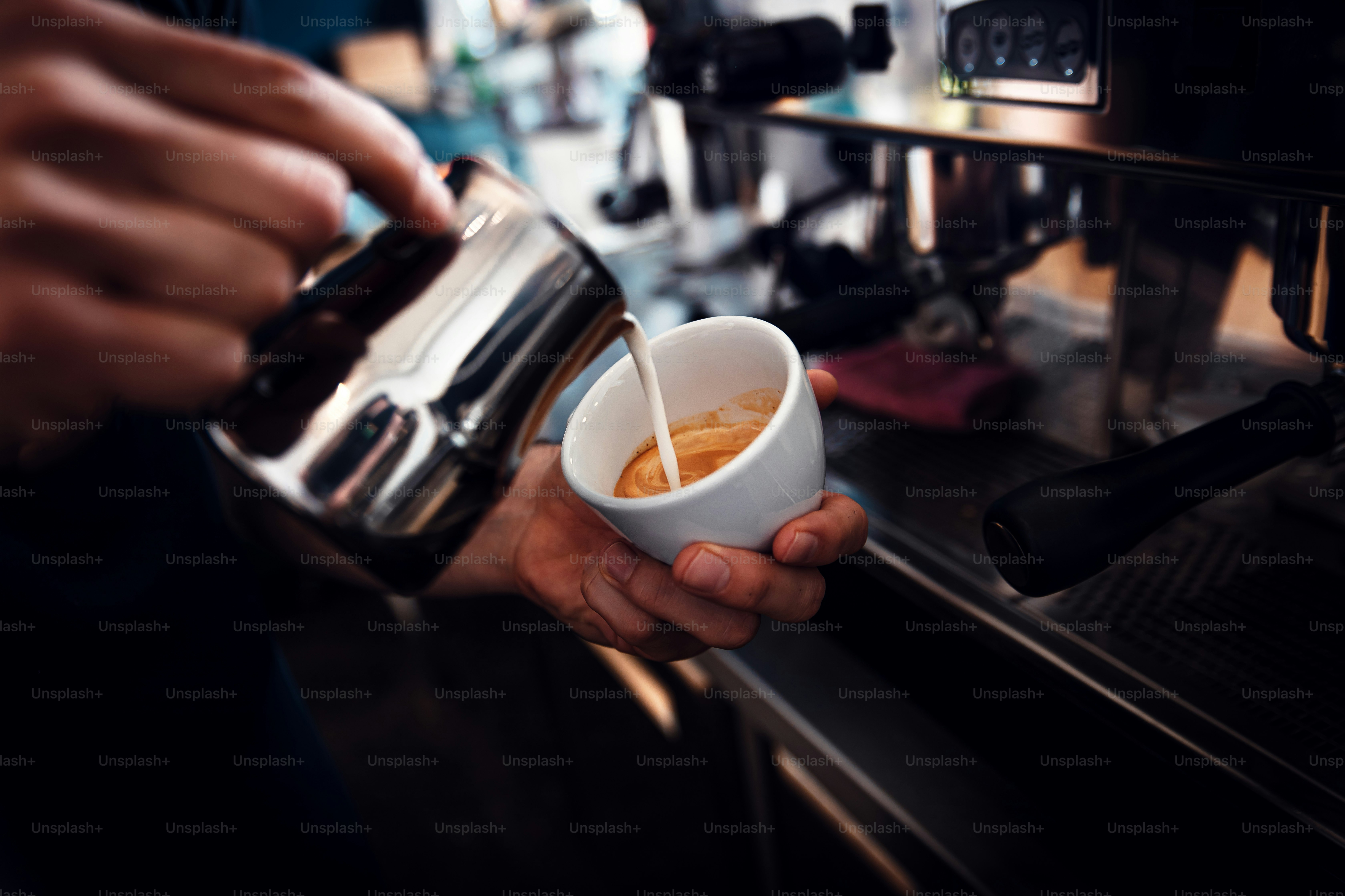 Close up of barista hands preparing cappuccino on espresso machine for ...