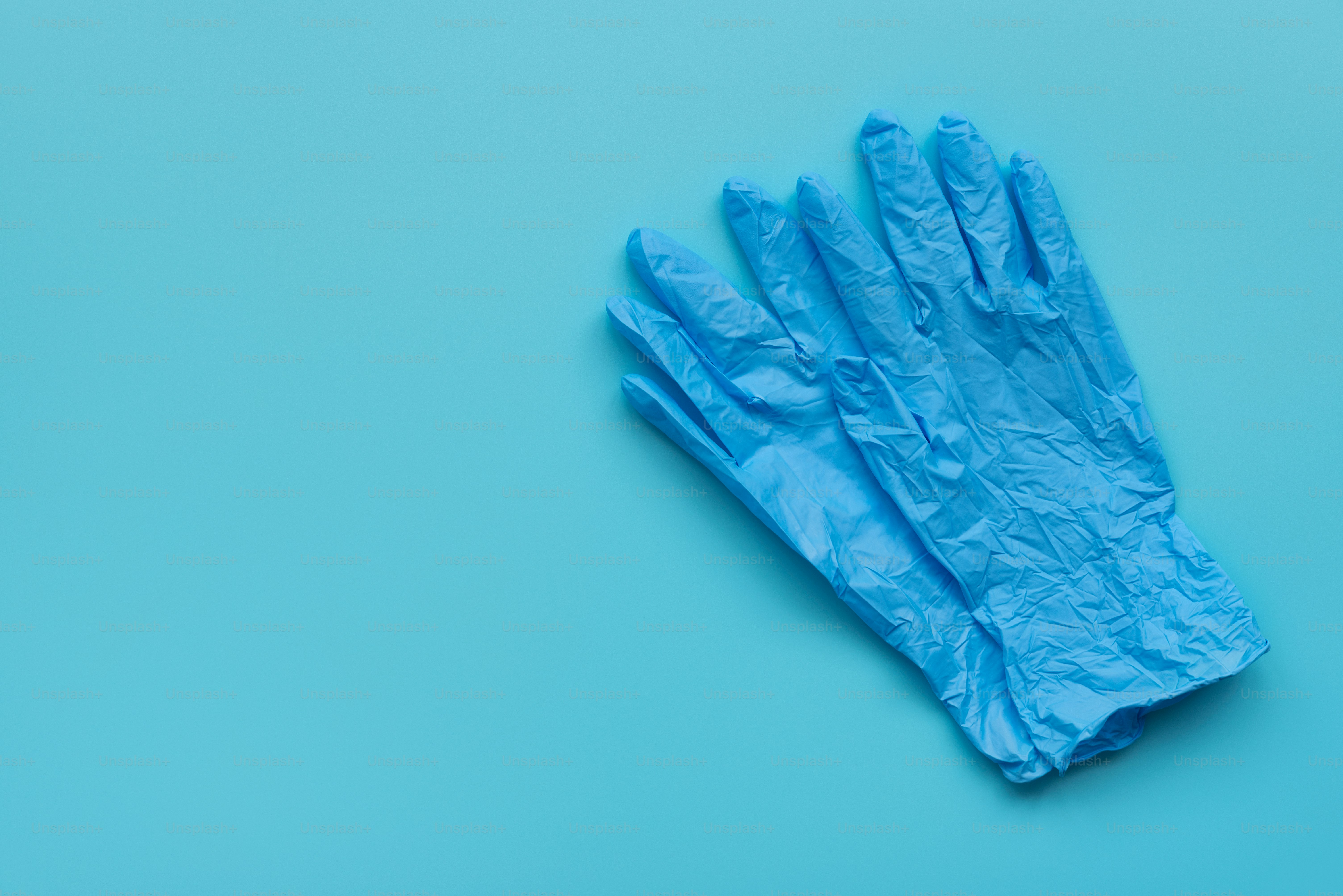 Pair of latex medical gloves ob blue background. Protection concept ...