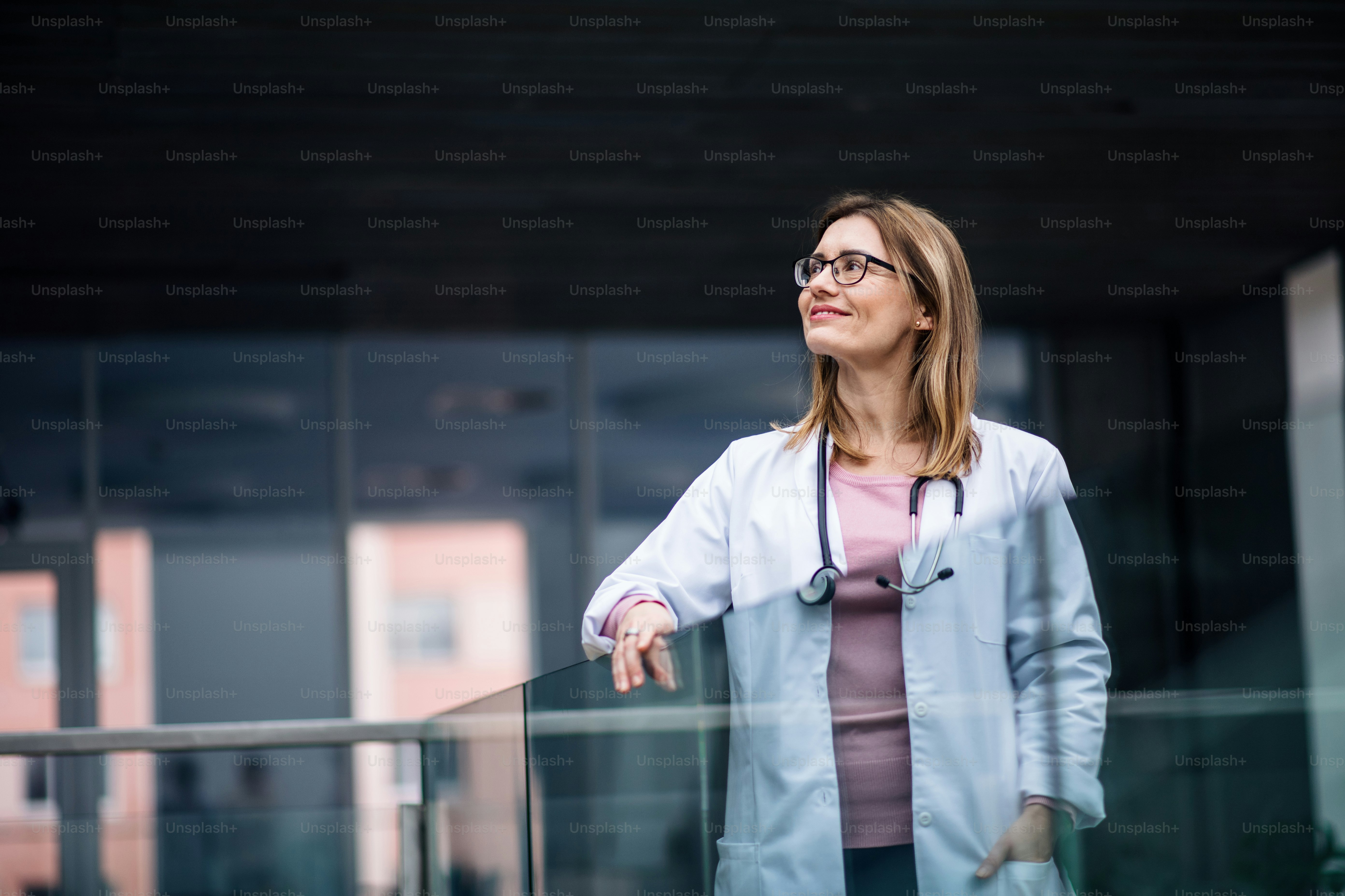 A group of doctors standing in hospital corridor on medical conference ...