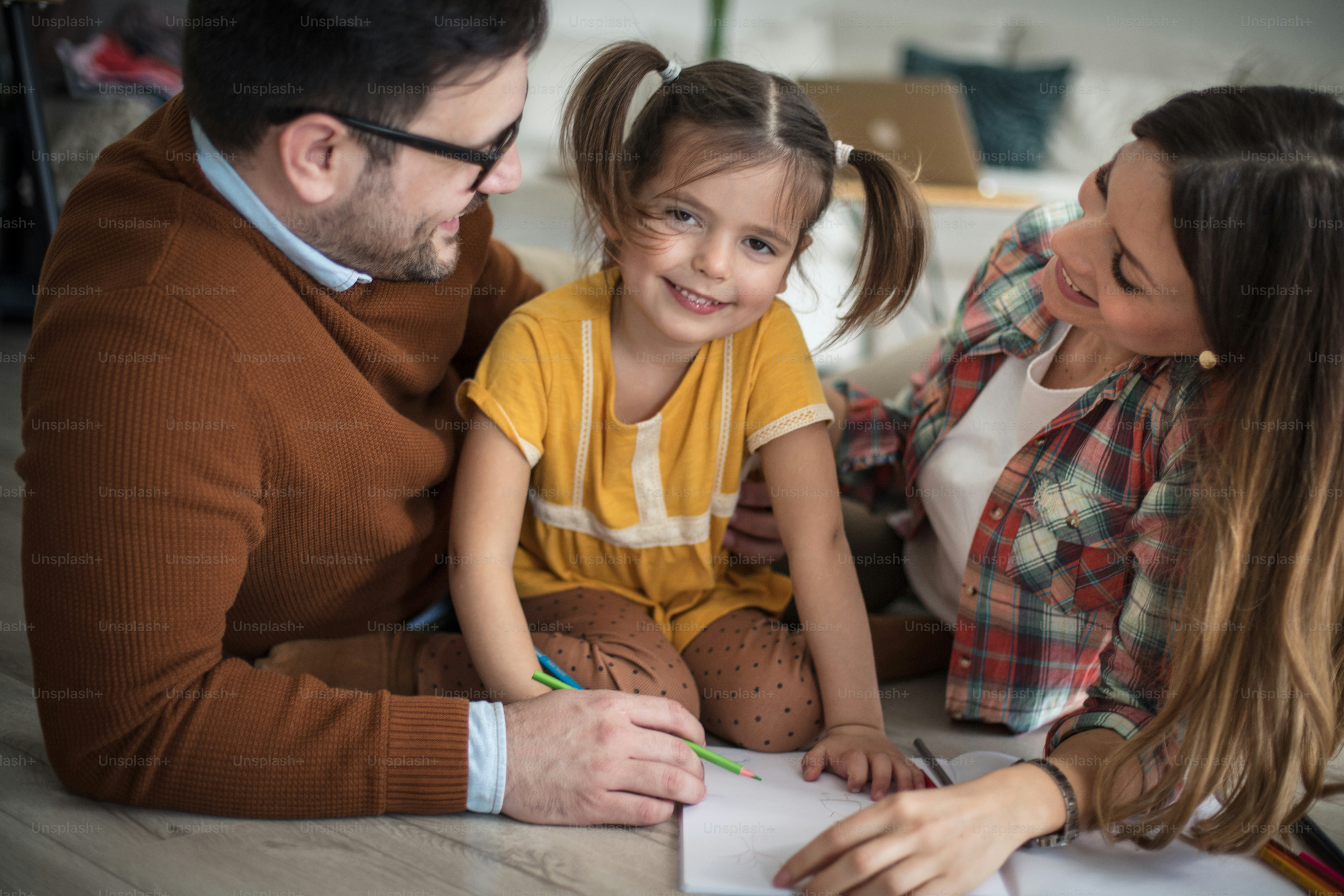 We spend our free time together. Parents help their daughter with ...