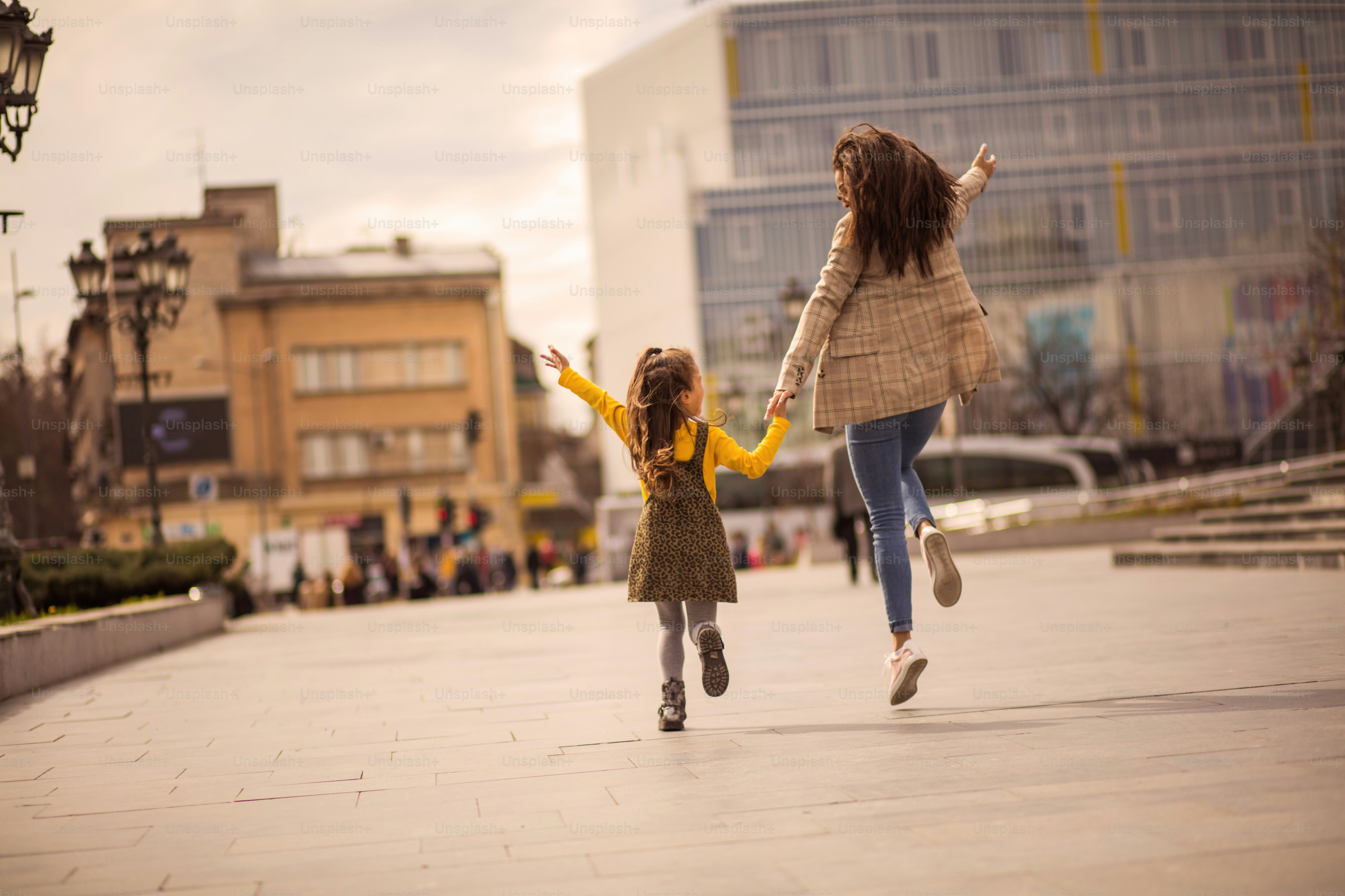 Jus us girls. African American mother with her daughter at the city ...