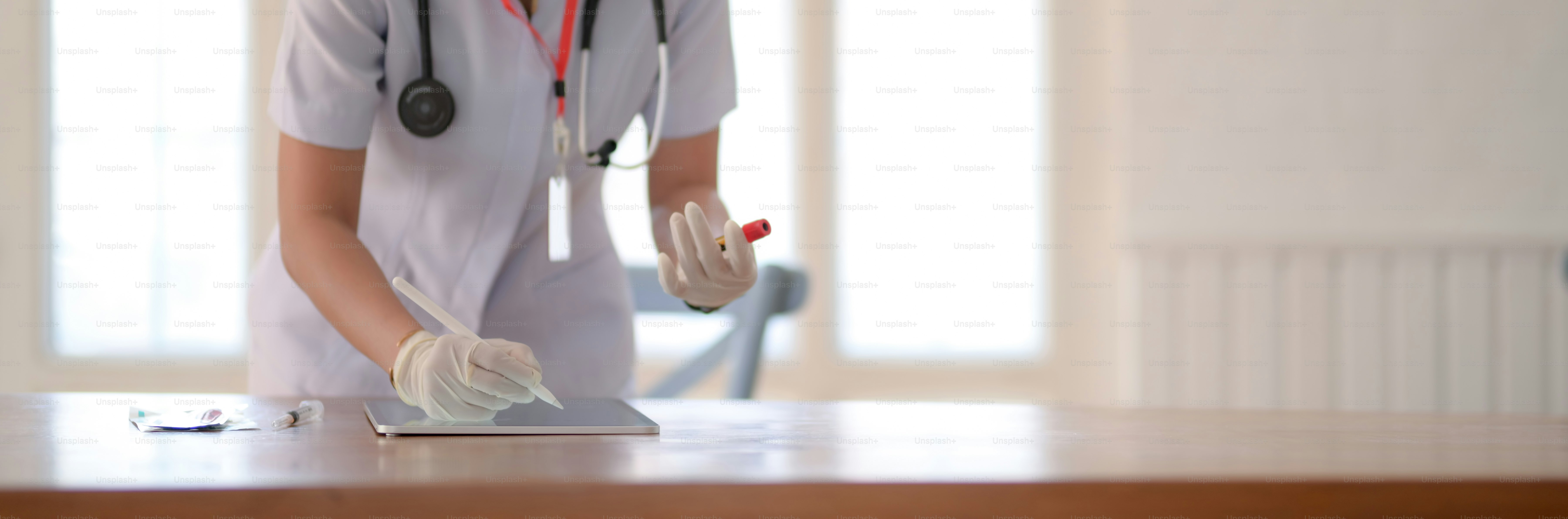 Close up view of female doctor writing blood tests on digital tablet ...