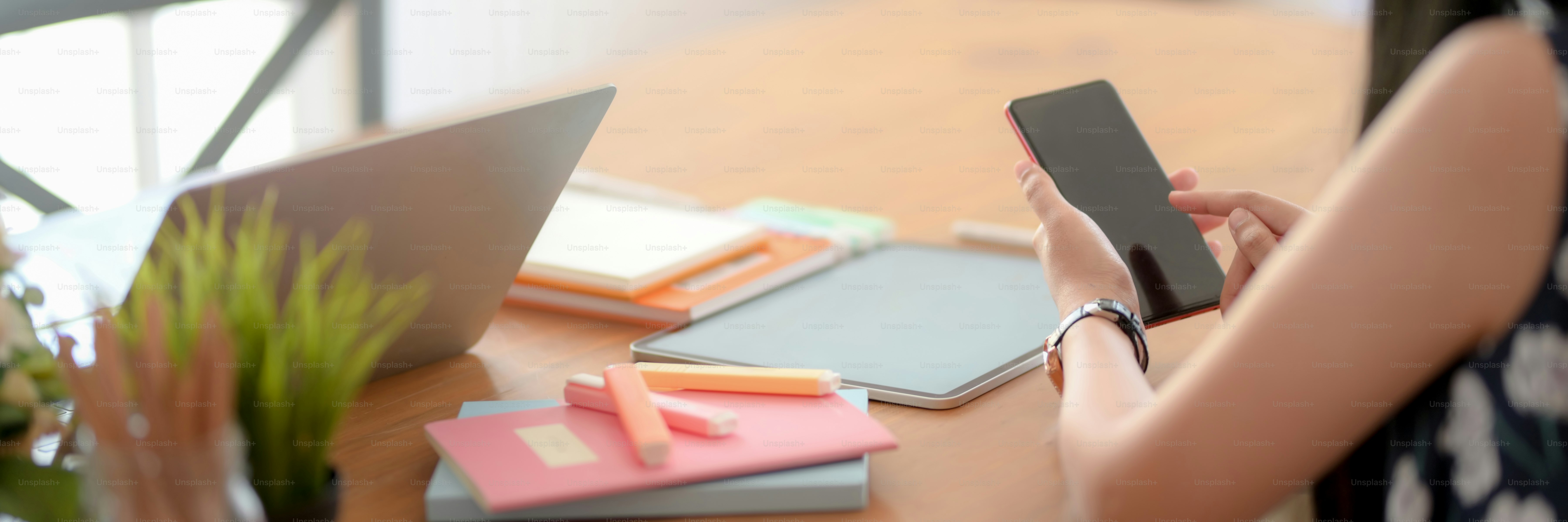 Cropped shot of young female college student using smartphone to relax ...