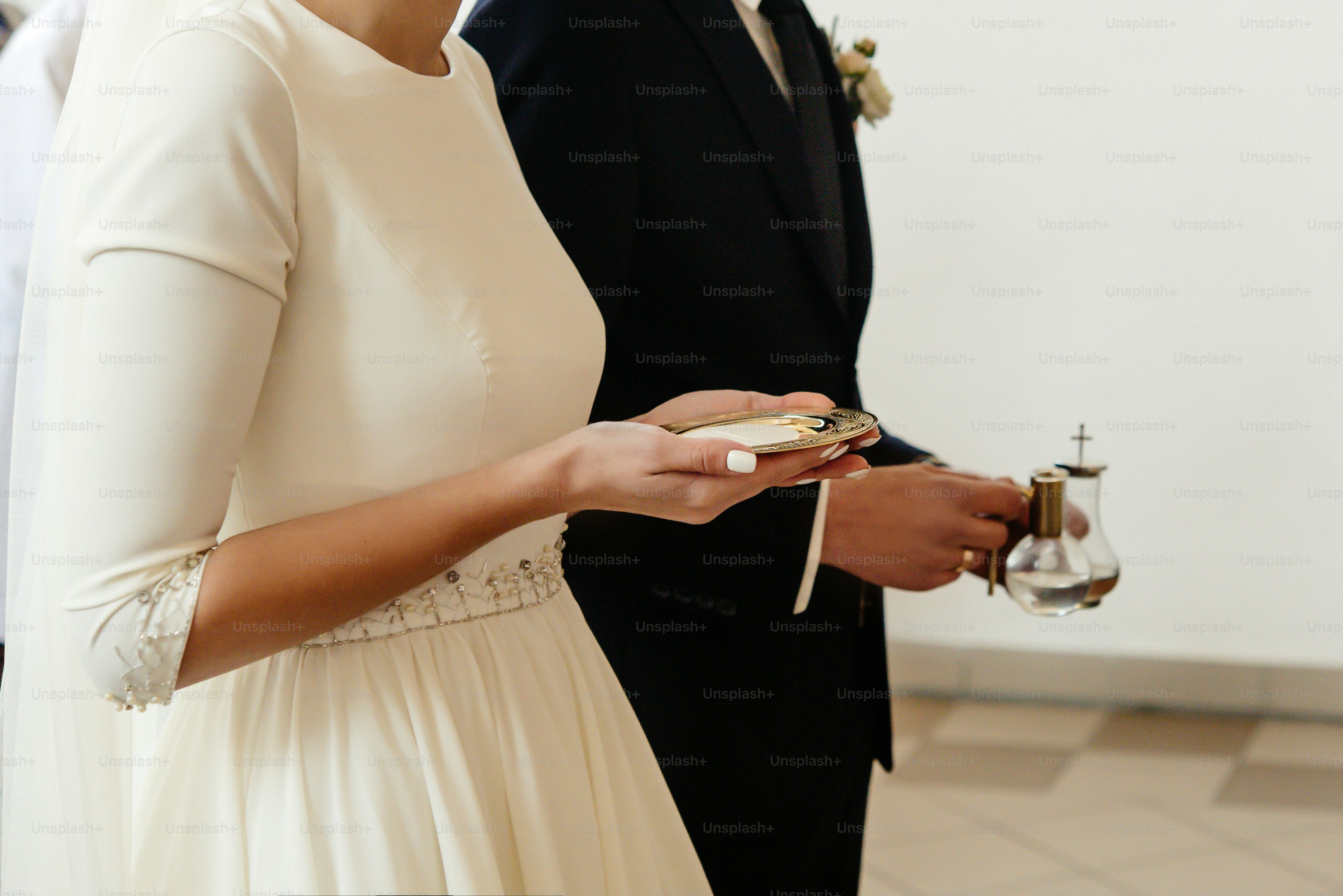 Hands of bride and groom preparing for communion at wedding ceremony in ...