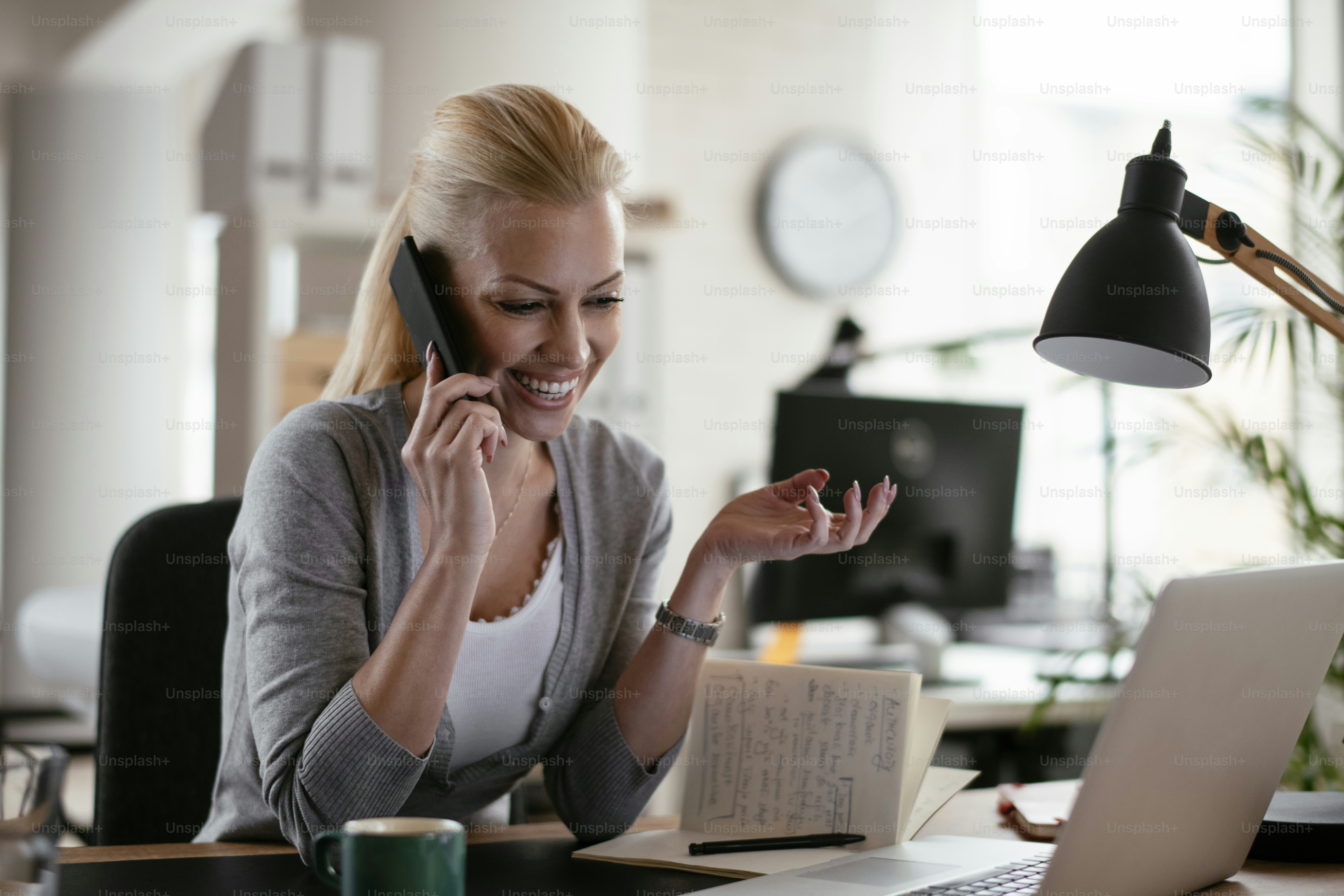 Young businesswoman working in office. Beautiful happy woman working on ...