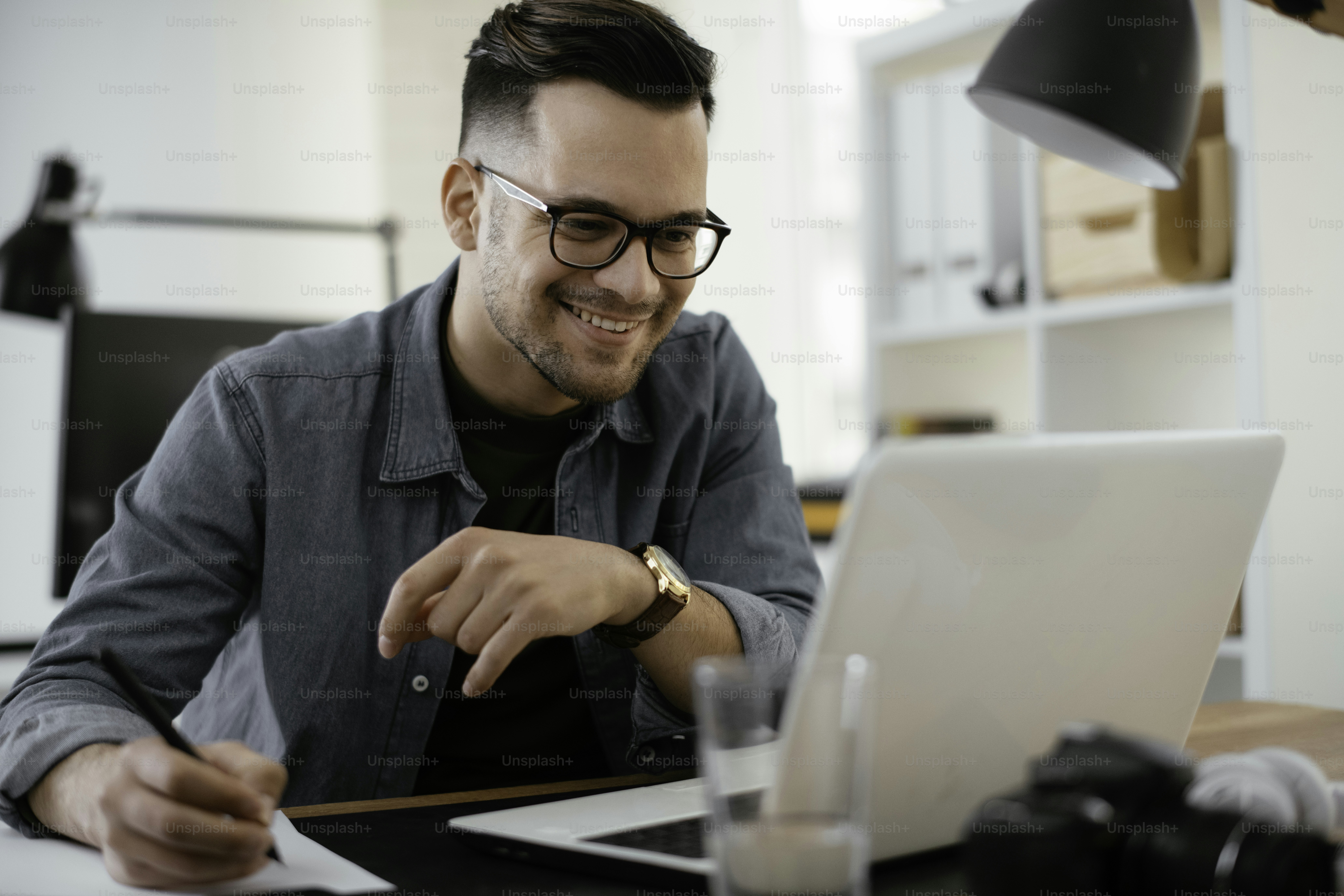 Handsome businessman working in office. Young man working on lap top ...