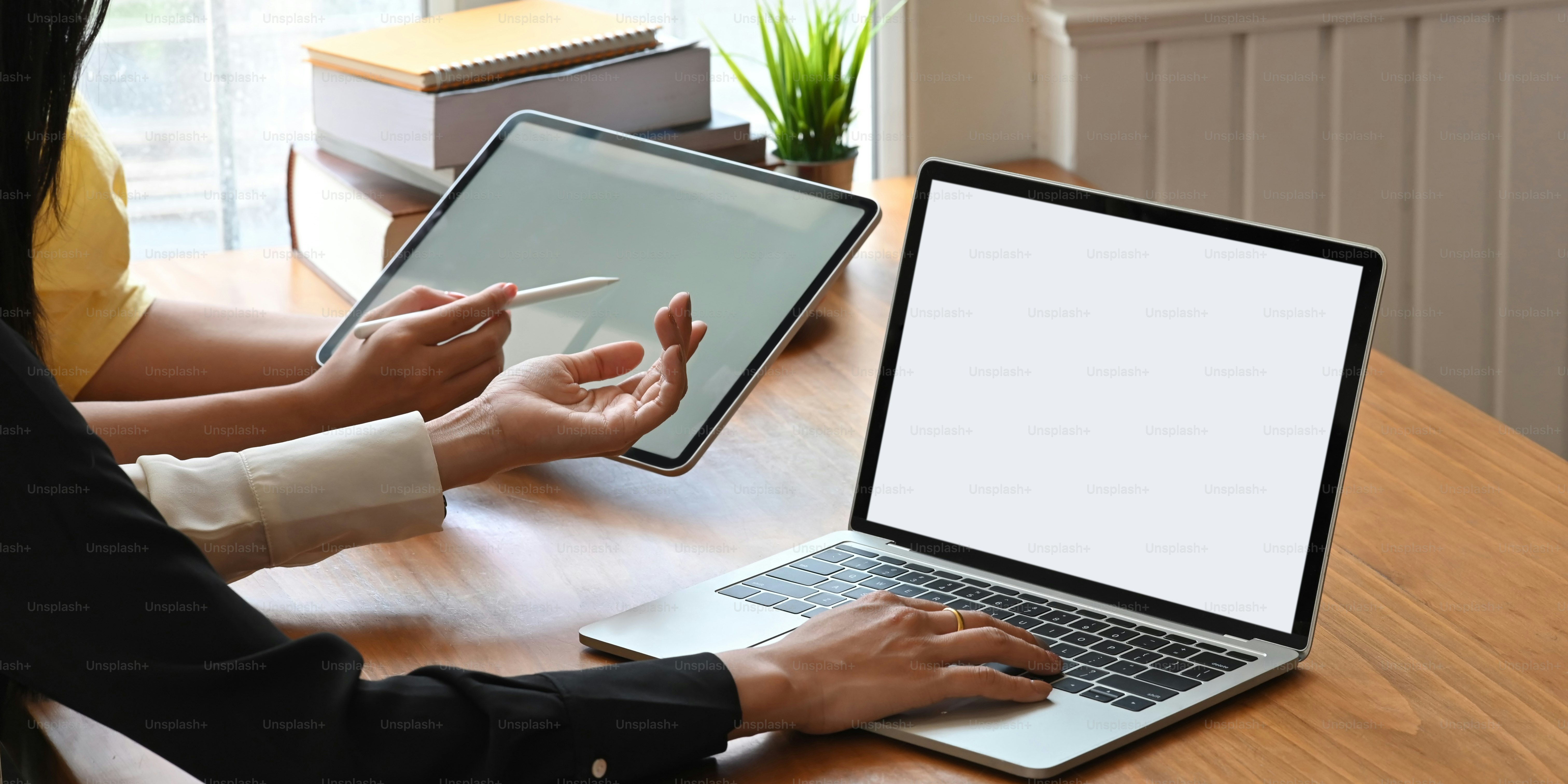 Cropped image of fashion stylist team working with white blank screen ...