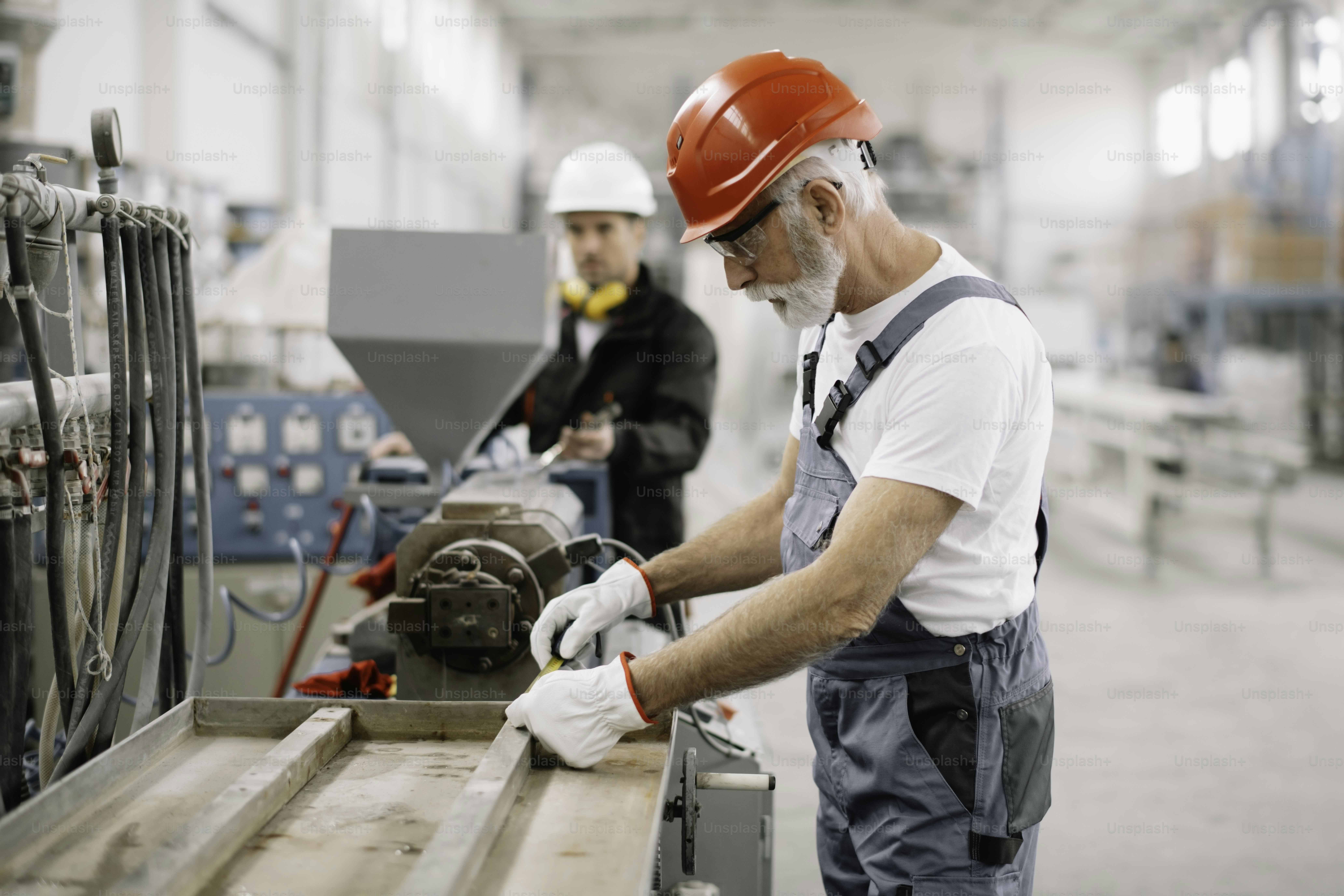 Colleagues working together in factory. Workers in factory. photo ...