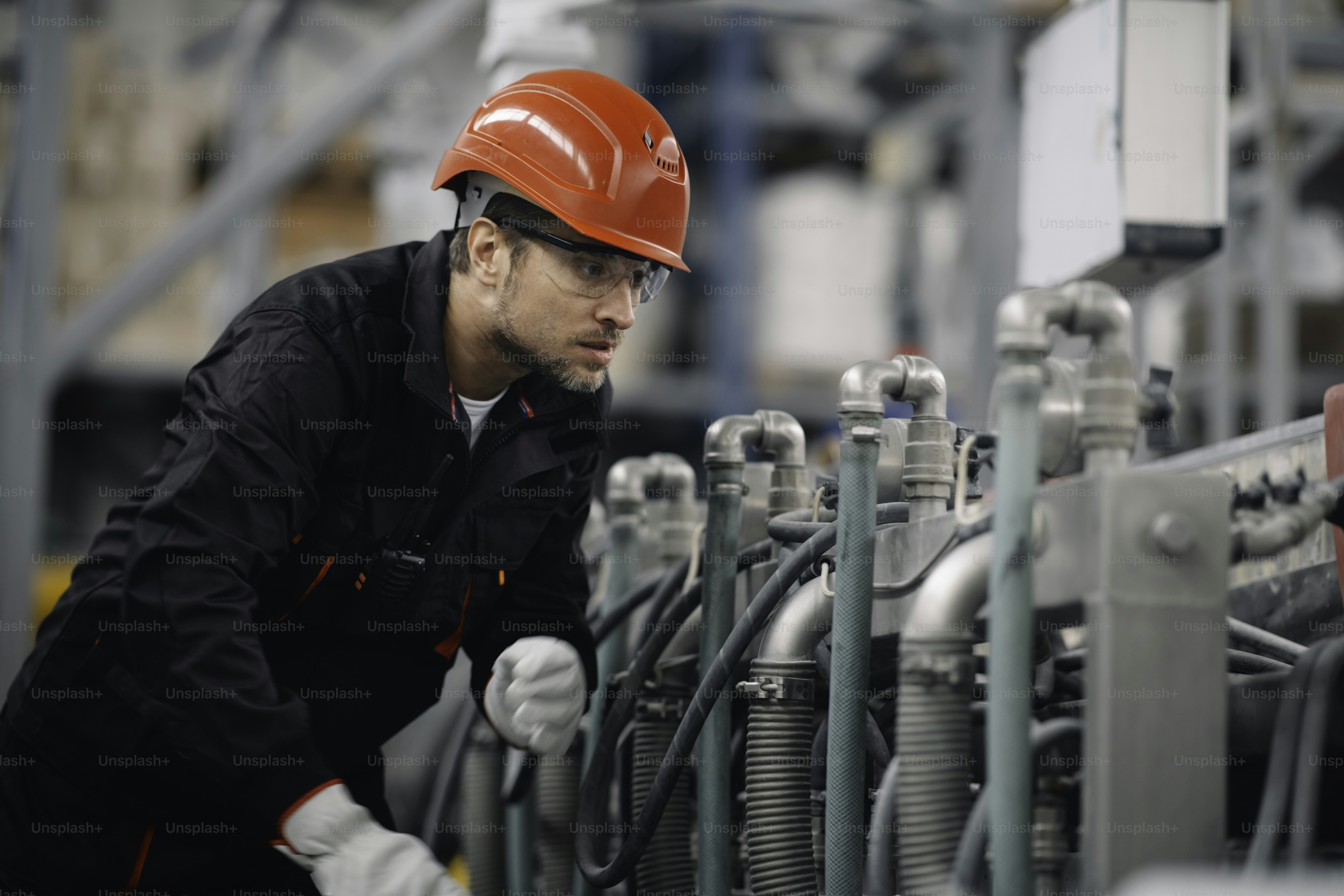 Portrait of worker in factory. Young handsome man working in factory ...