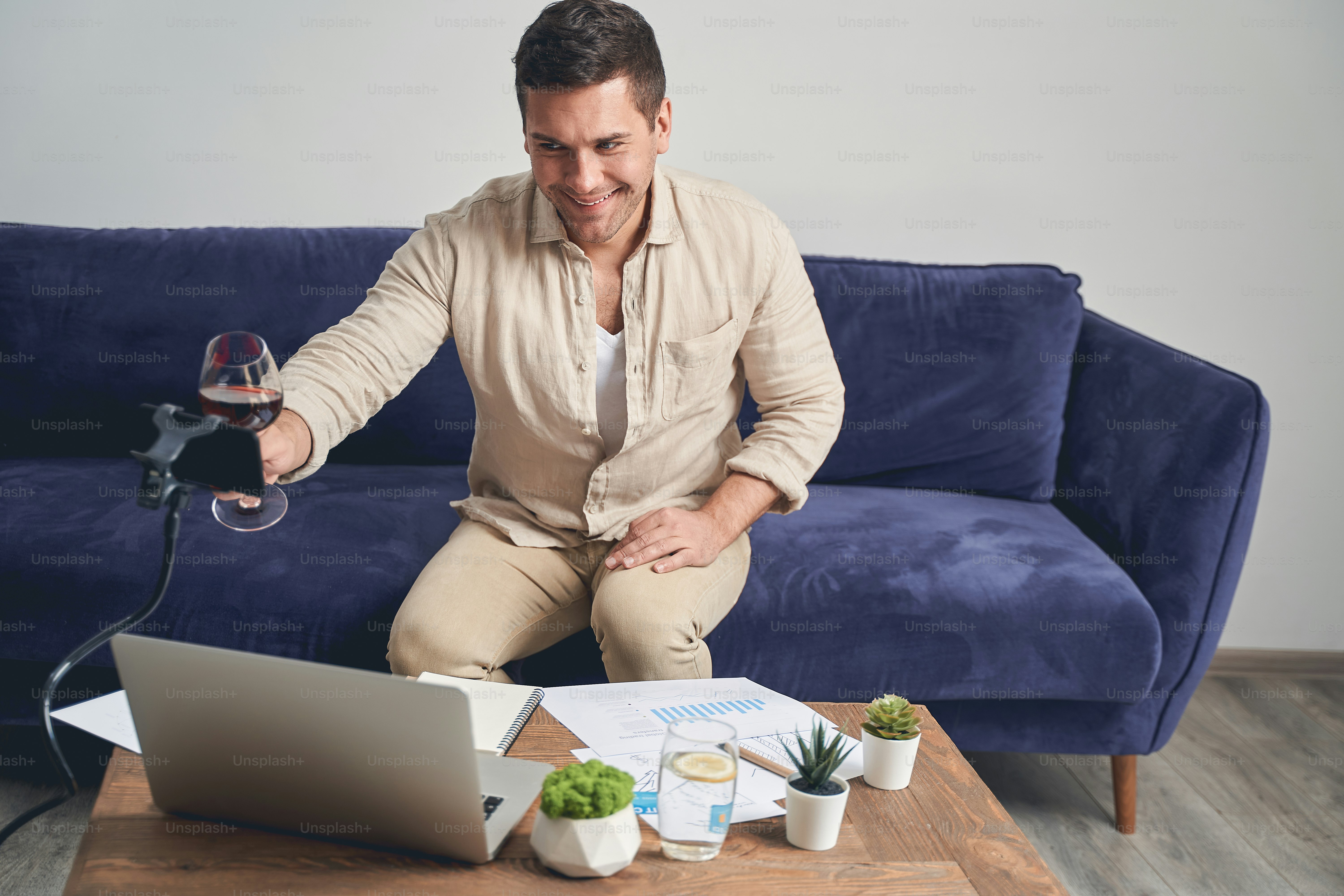 Handsome happy Caucasian middle-aged video blogger in self-isolation ...