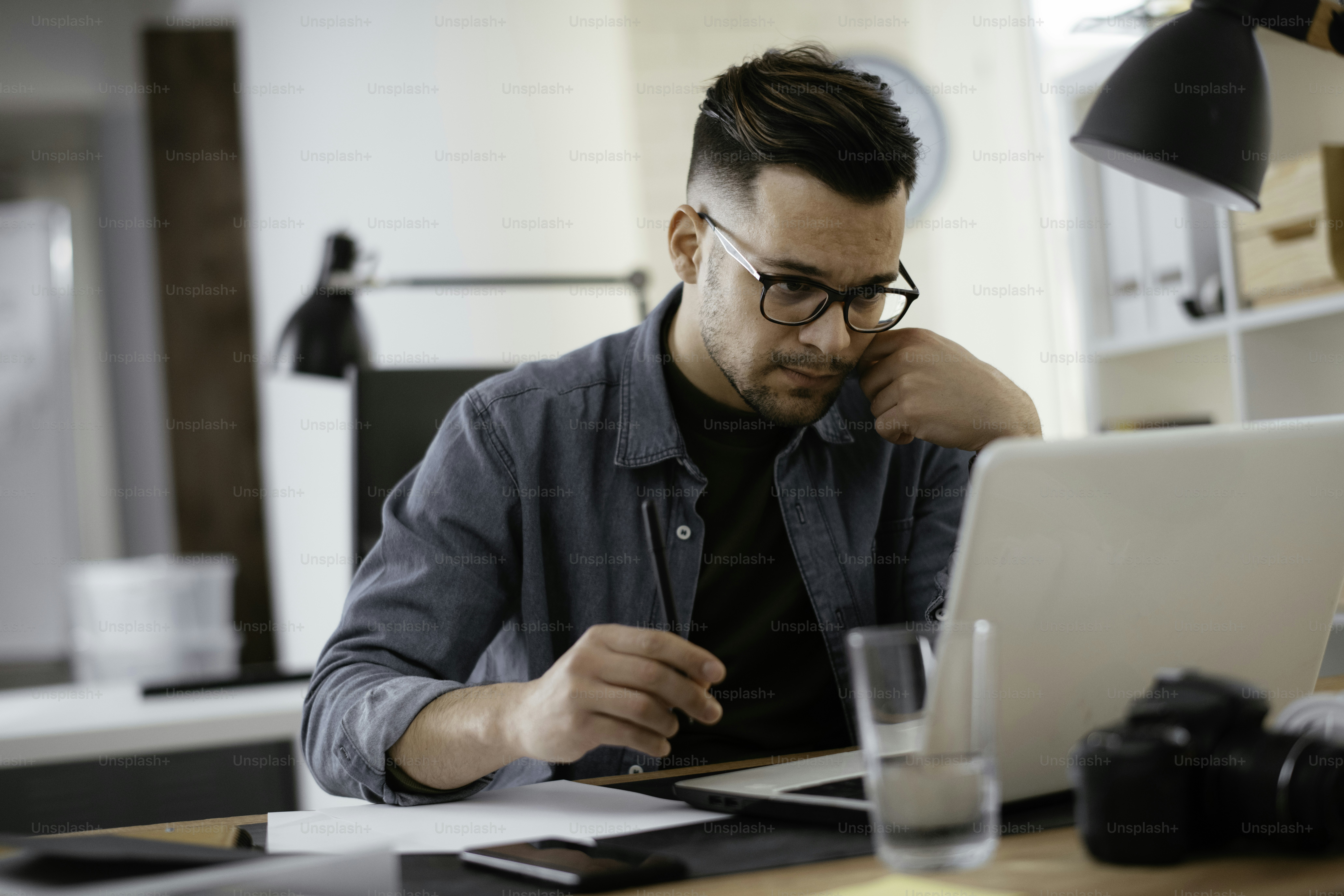 Businessman working on lap top. Young man working in office. photo ...