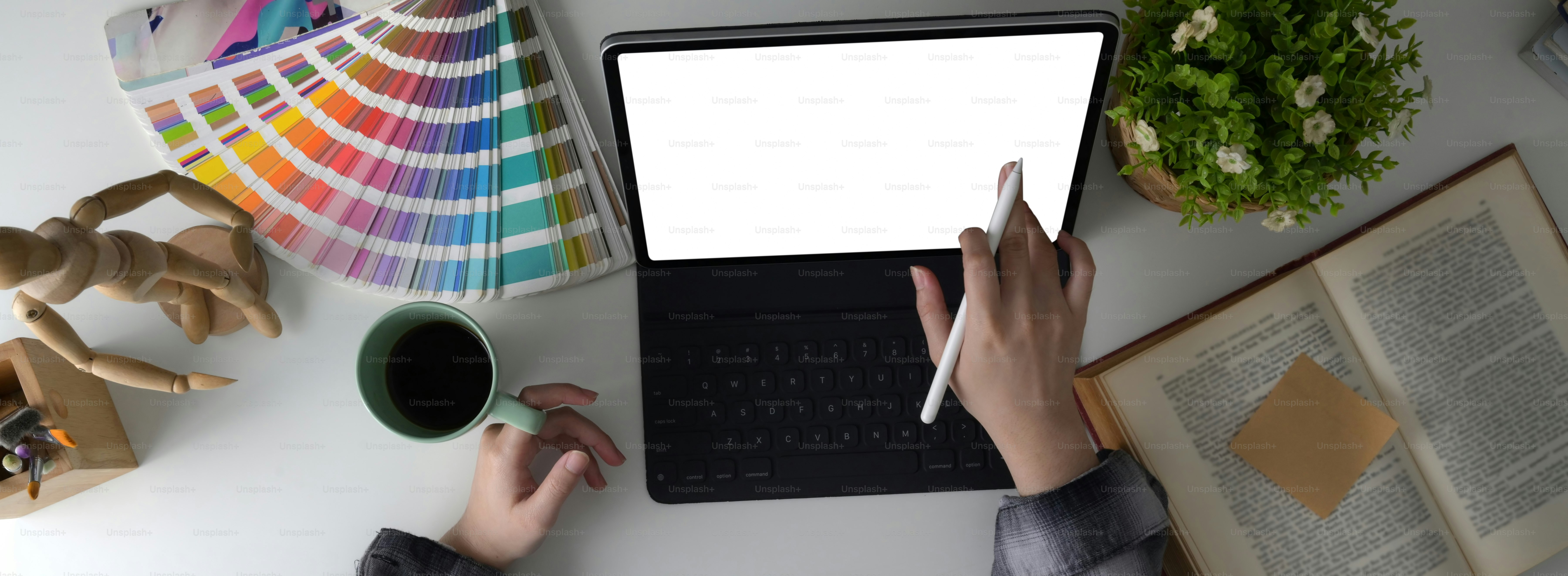 Overhead shot of female designer student doing her assignment with ...