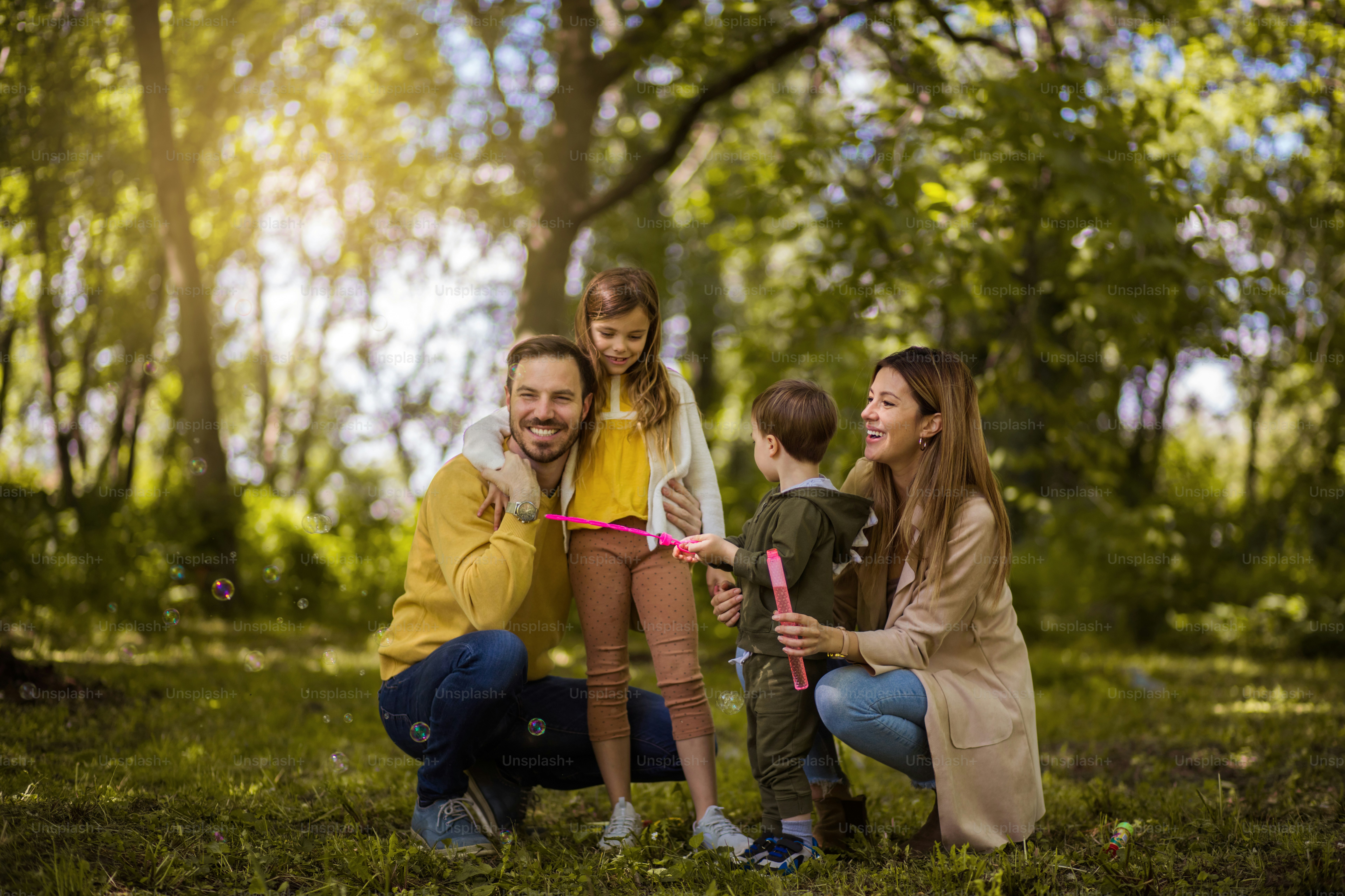 Unbreakable bond. Parents spending time with their children outside ...
