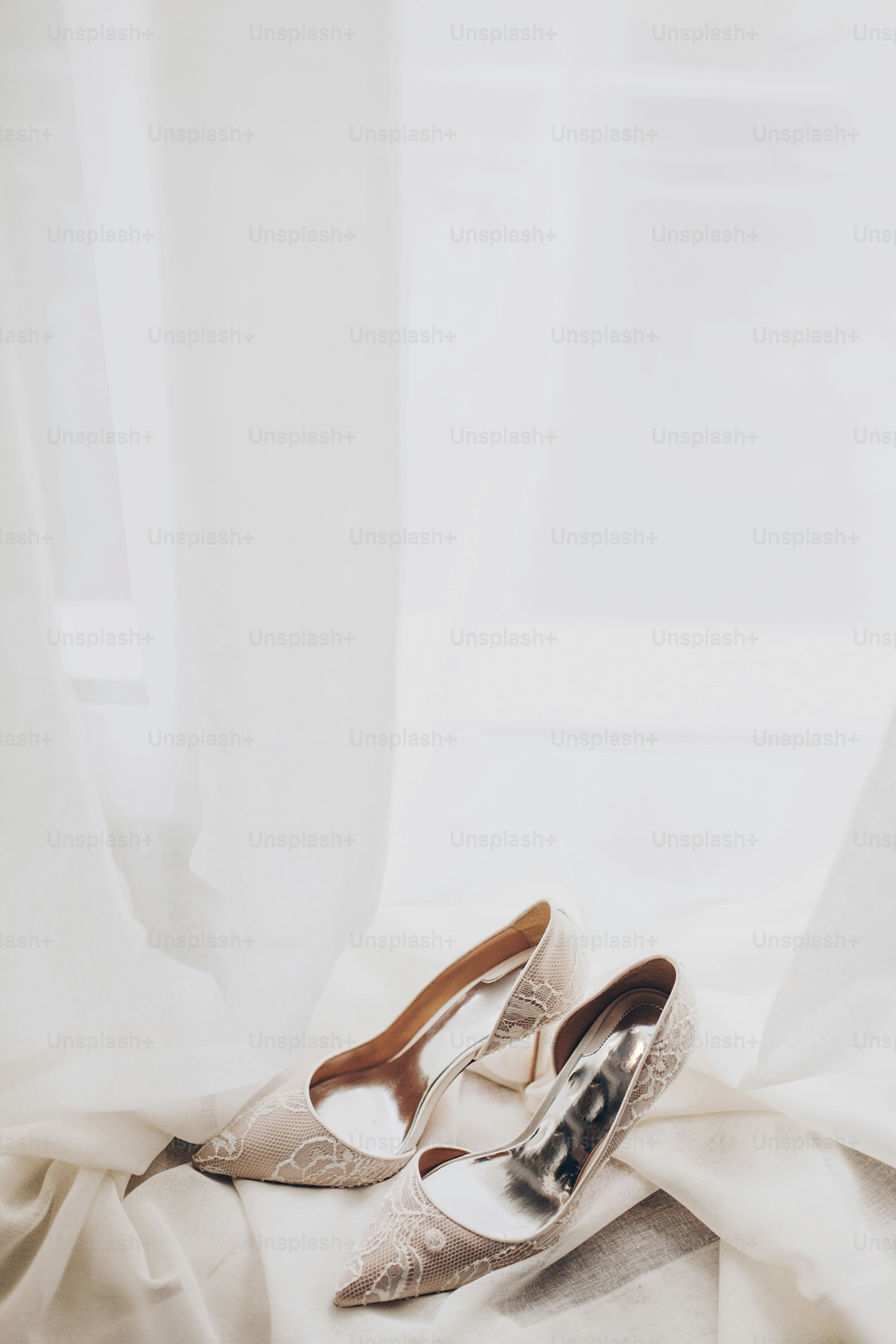 Modern wedding shoes on tulle in soft morning light. Stylish luxury ...