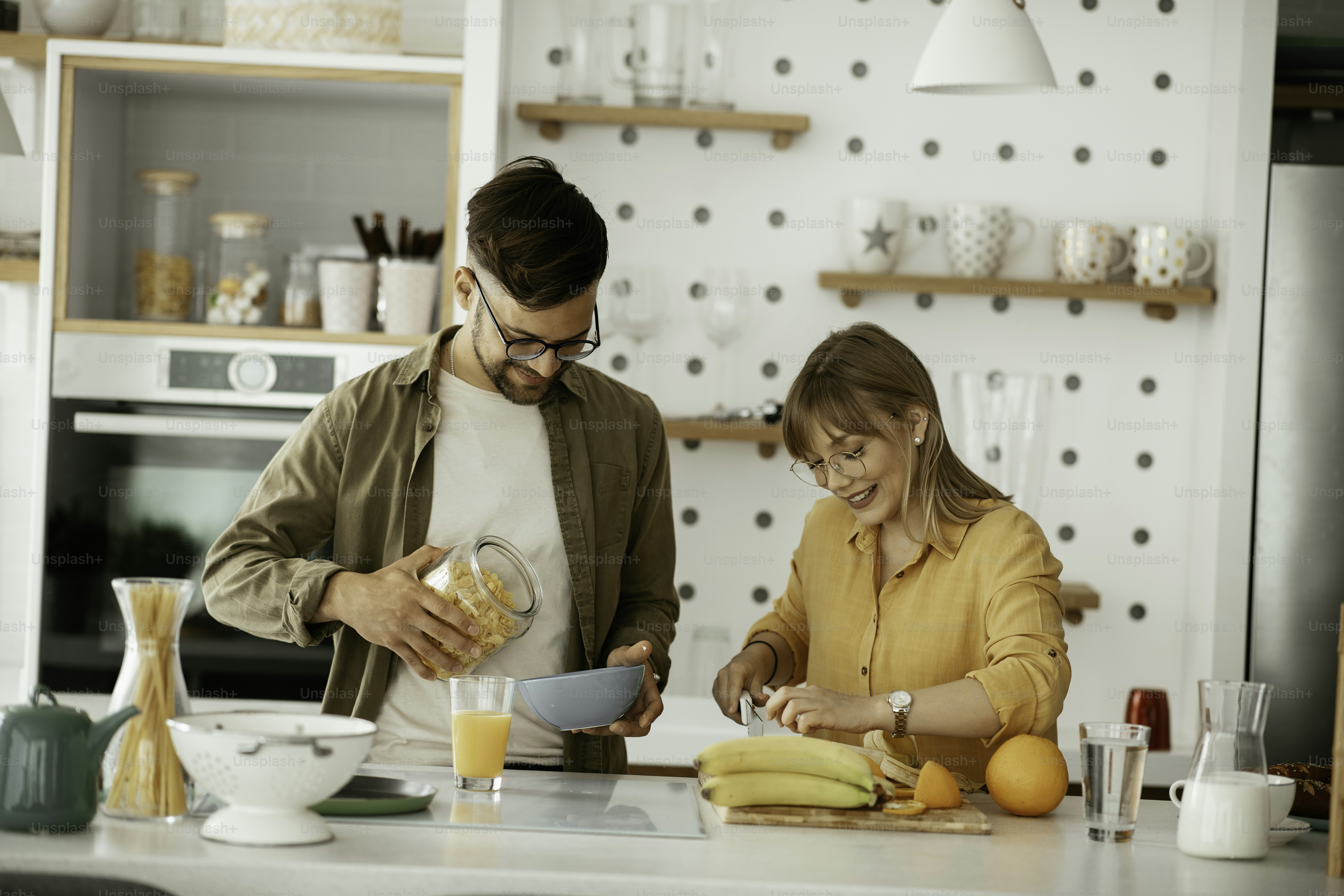 Young couple cooking together at home. Loving couple having fun while ...