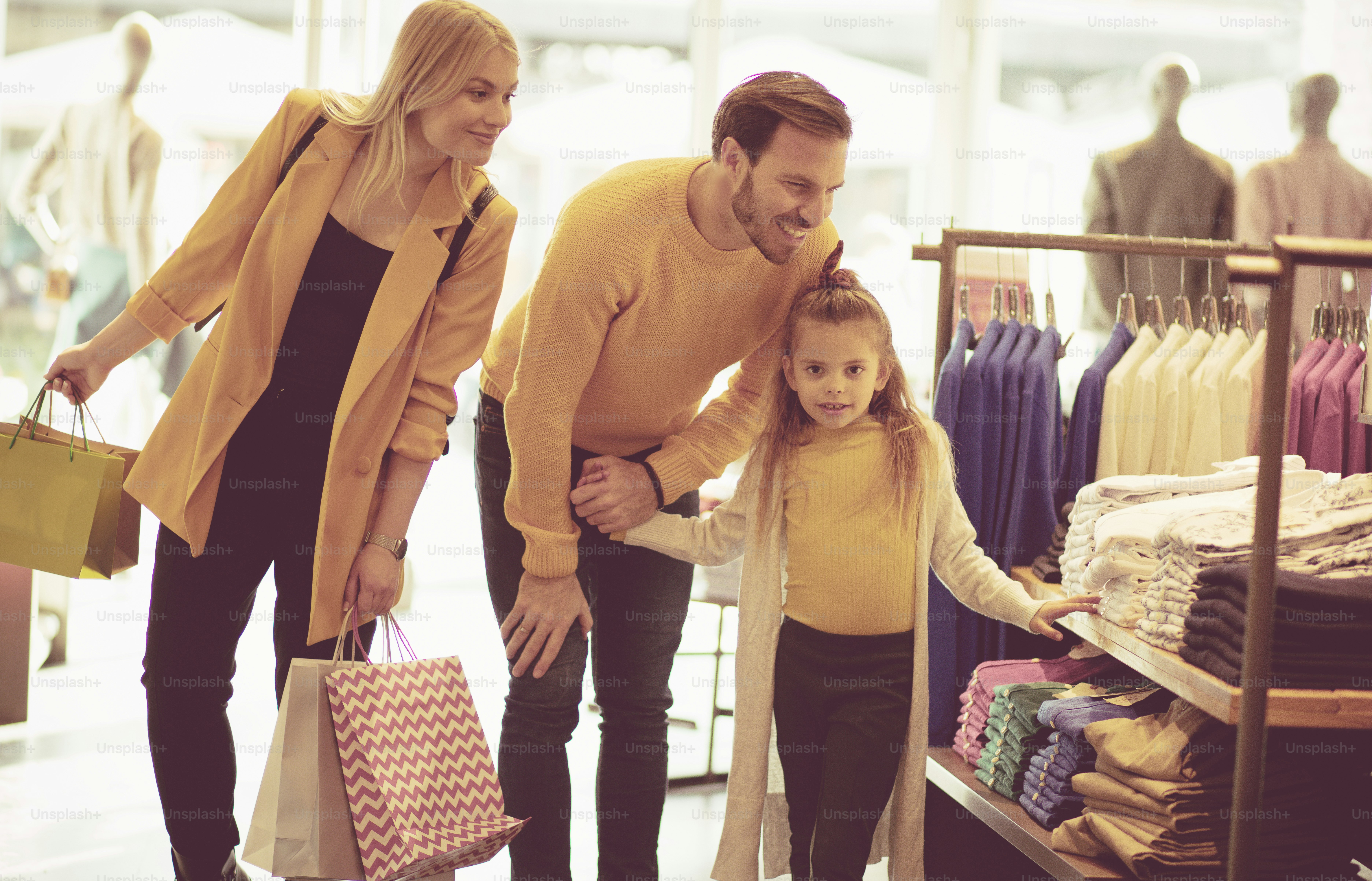 Beautiful clothe. Family in the shopping store. photo – Men Image on ...