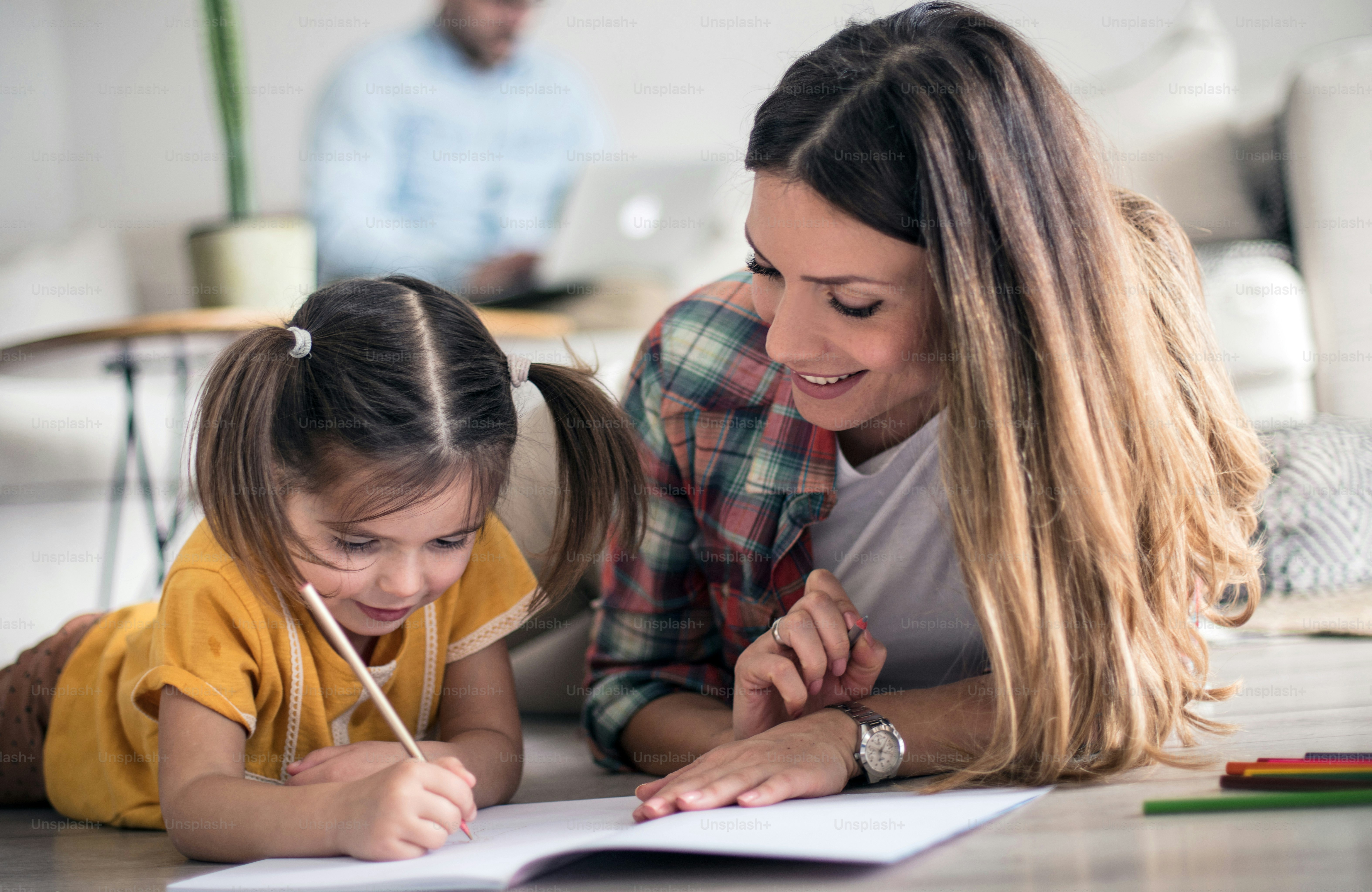 Help and encourage your kids. Family at home. Mother helping her ...