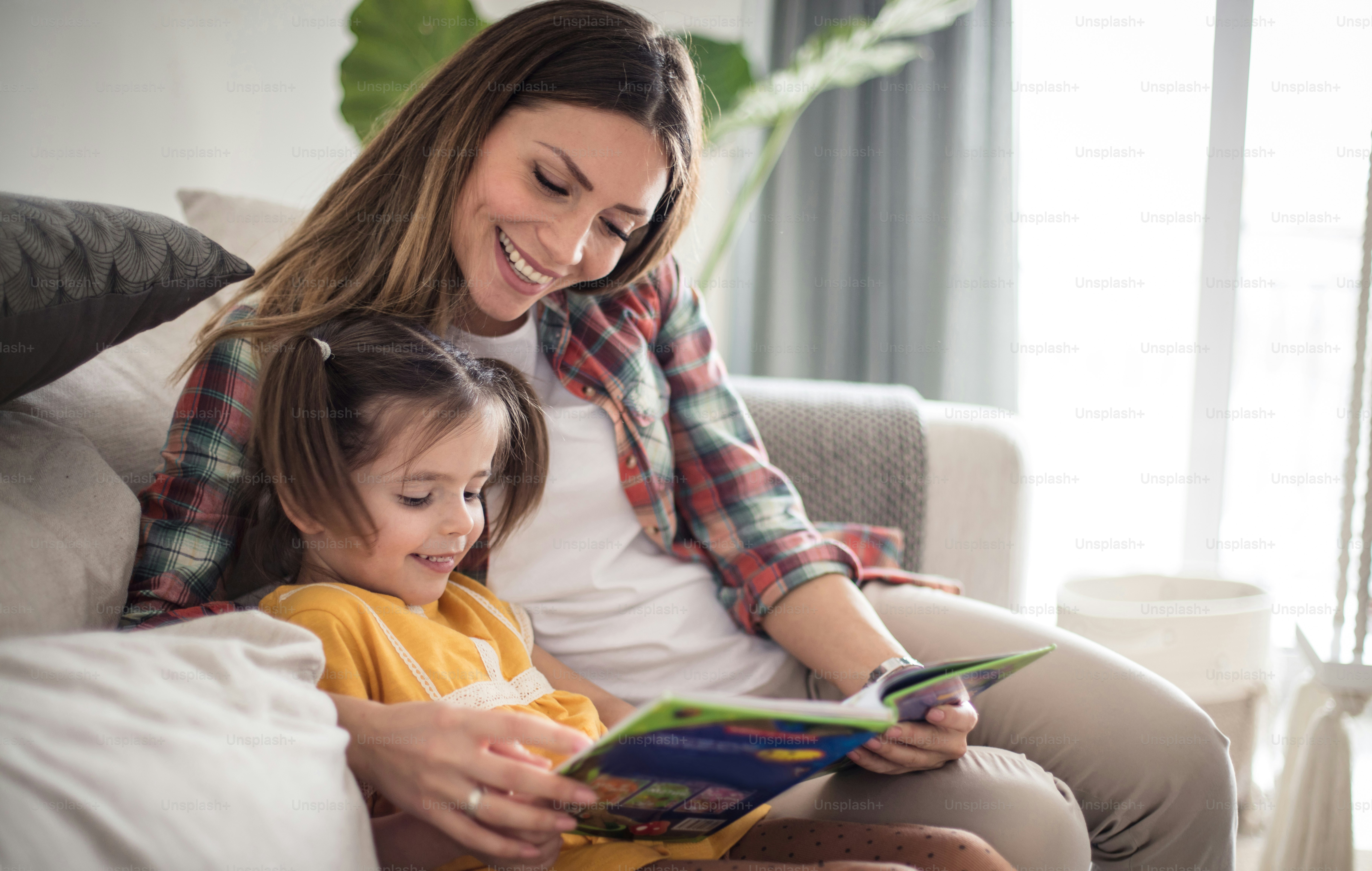 Story time. Mother and daughter reading book. photo – Book Image on ...