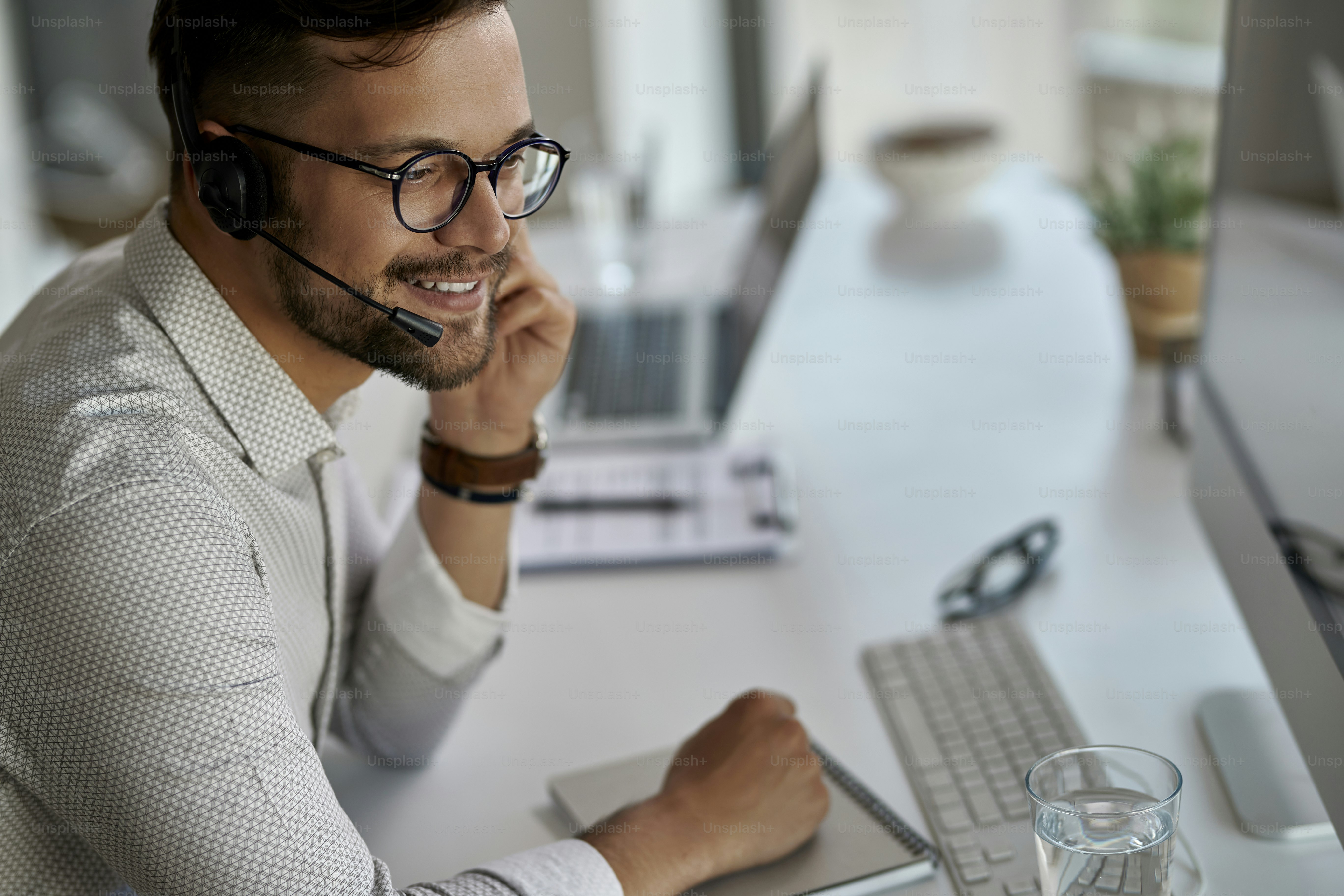 Young happy customer service representative working at call center ...