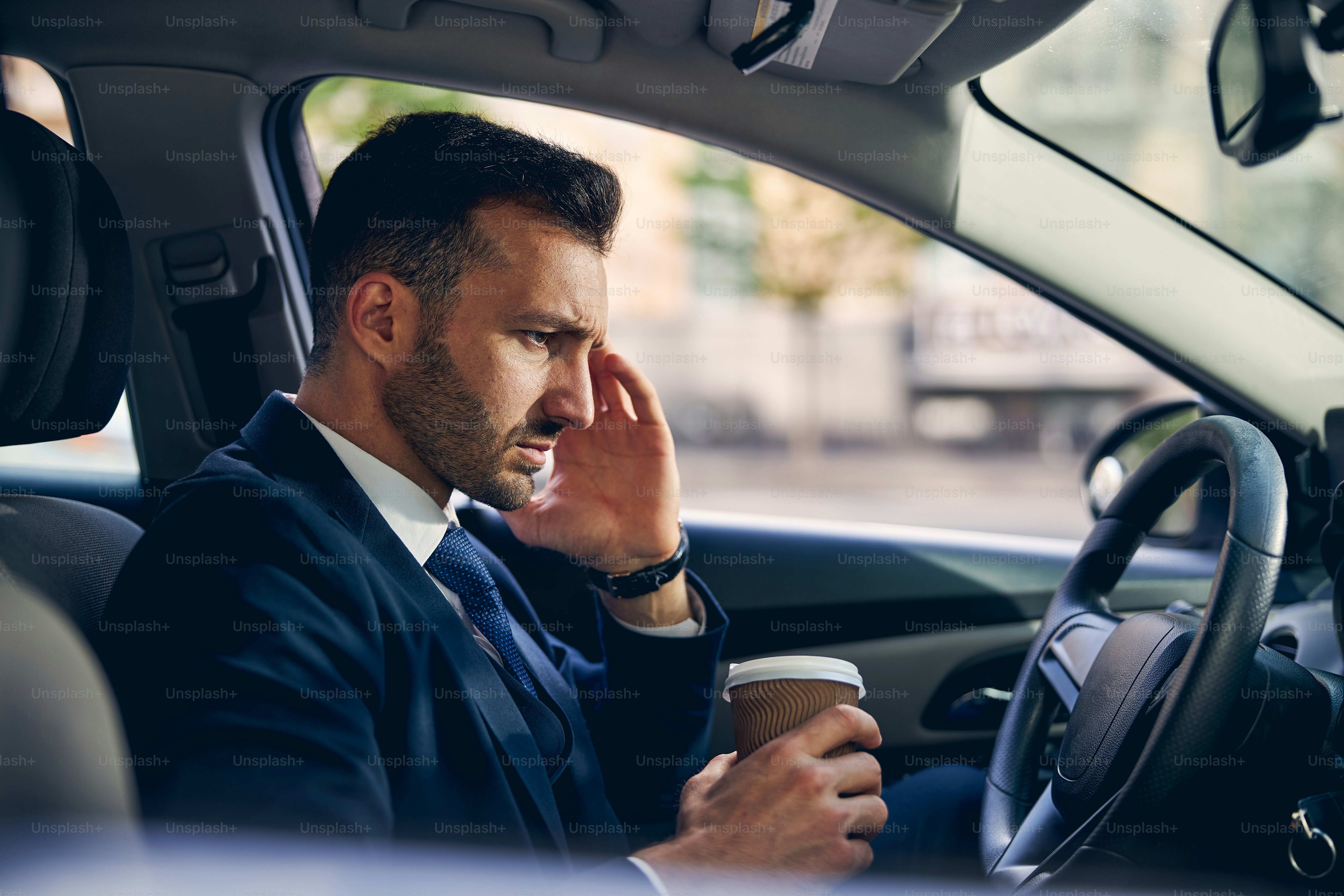 Handsome brunette man in formal clothes with coffee in hand touching ...