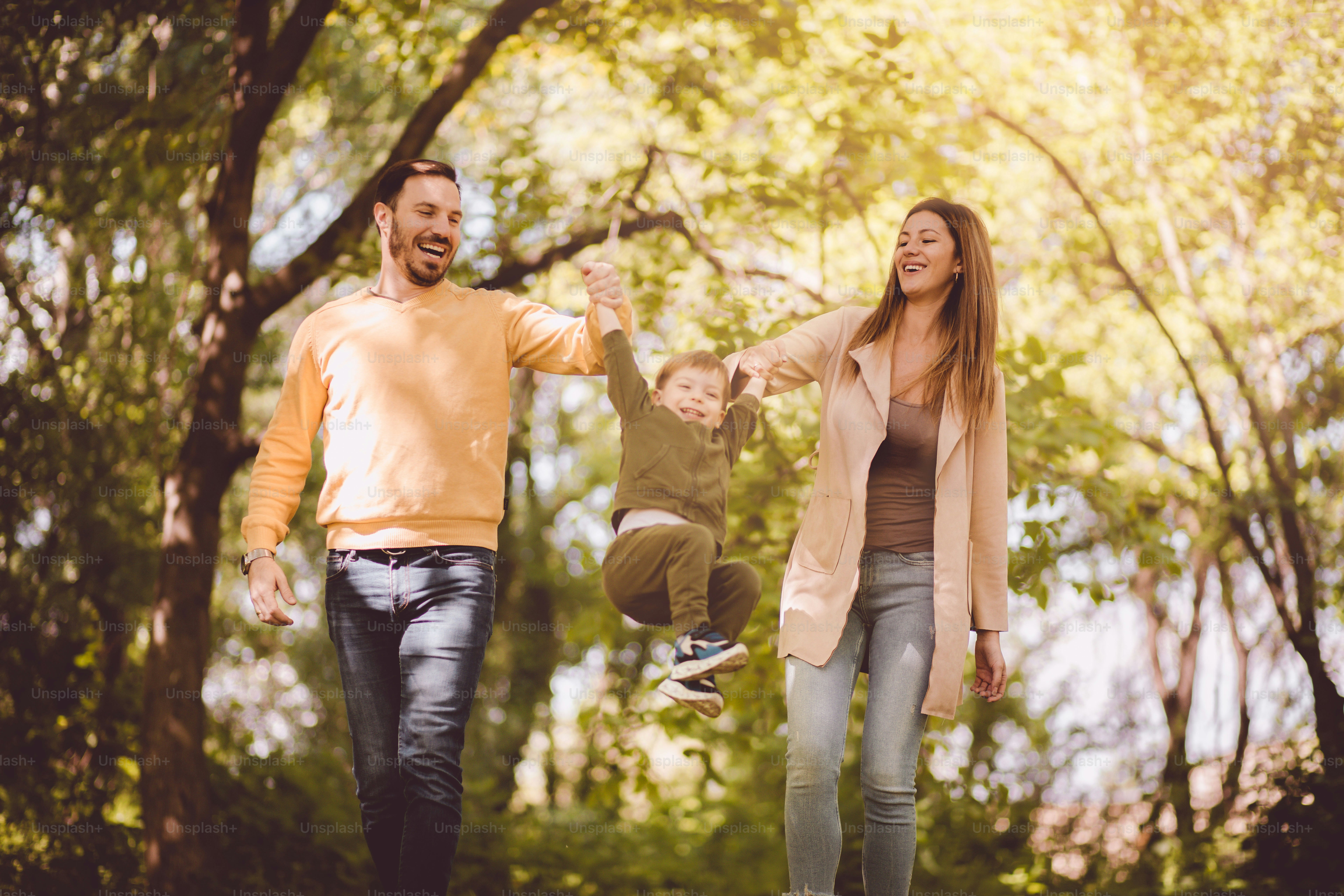 Happy childhood. Parents spending time with son outside. photo – Free ...