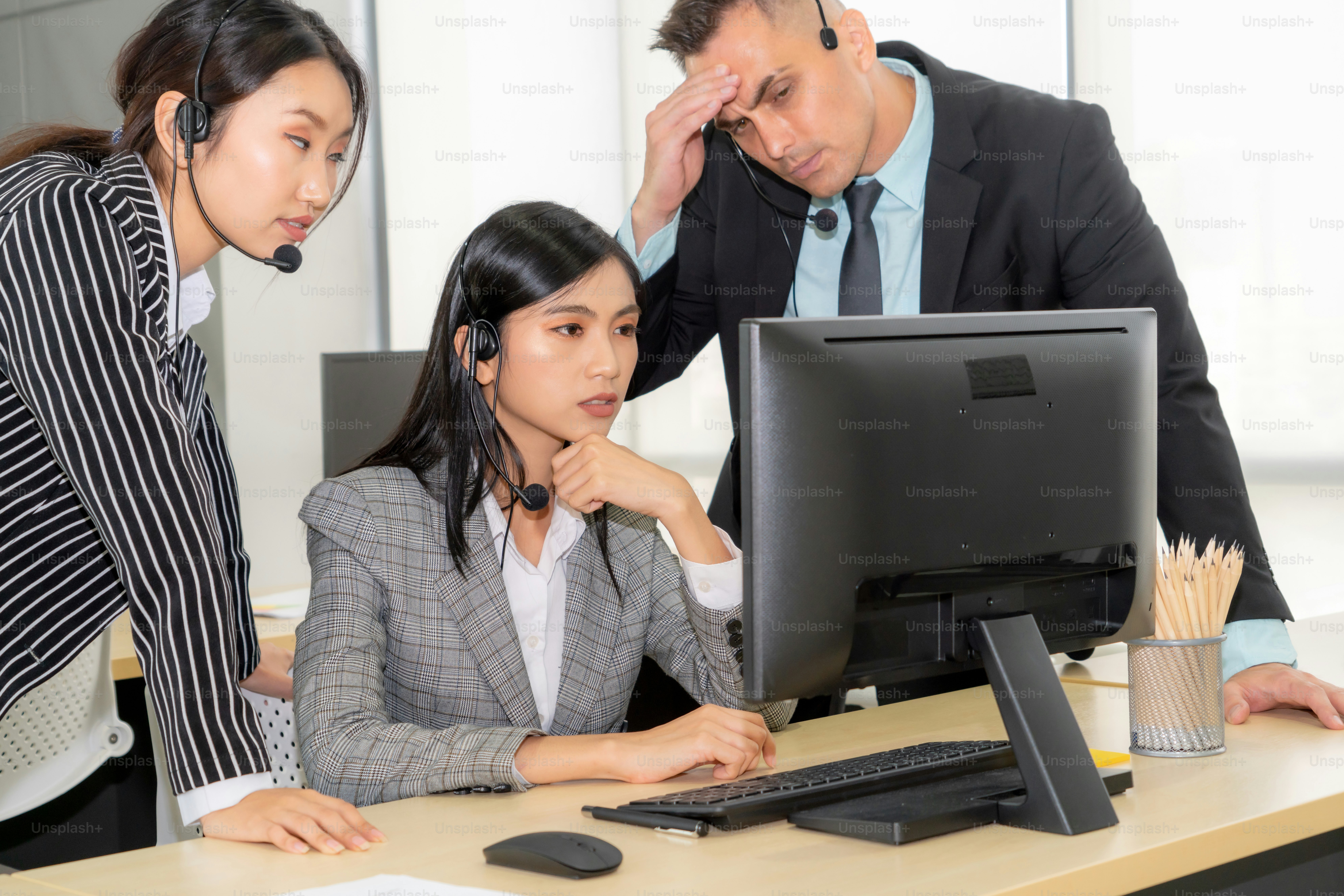 Business people wearing headset feel unhappy working in office ...