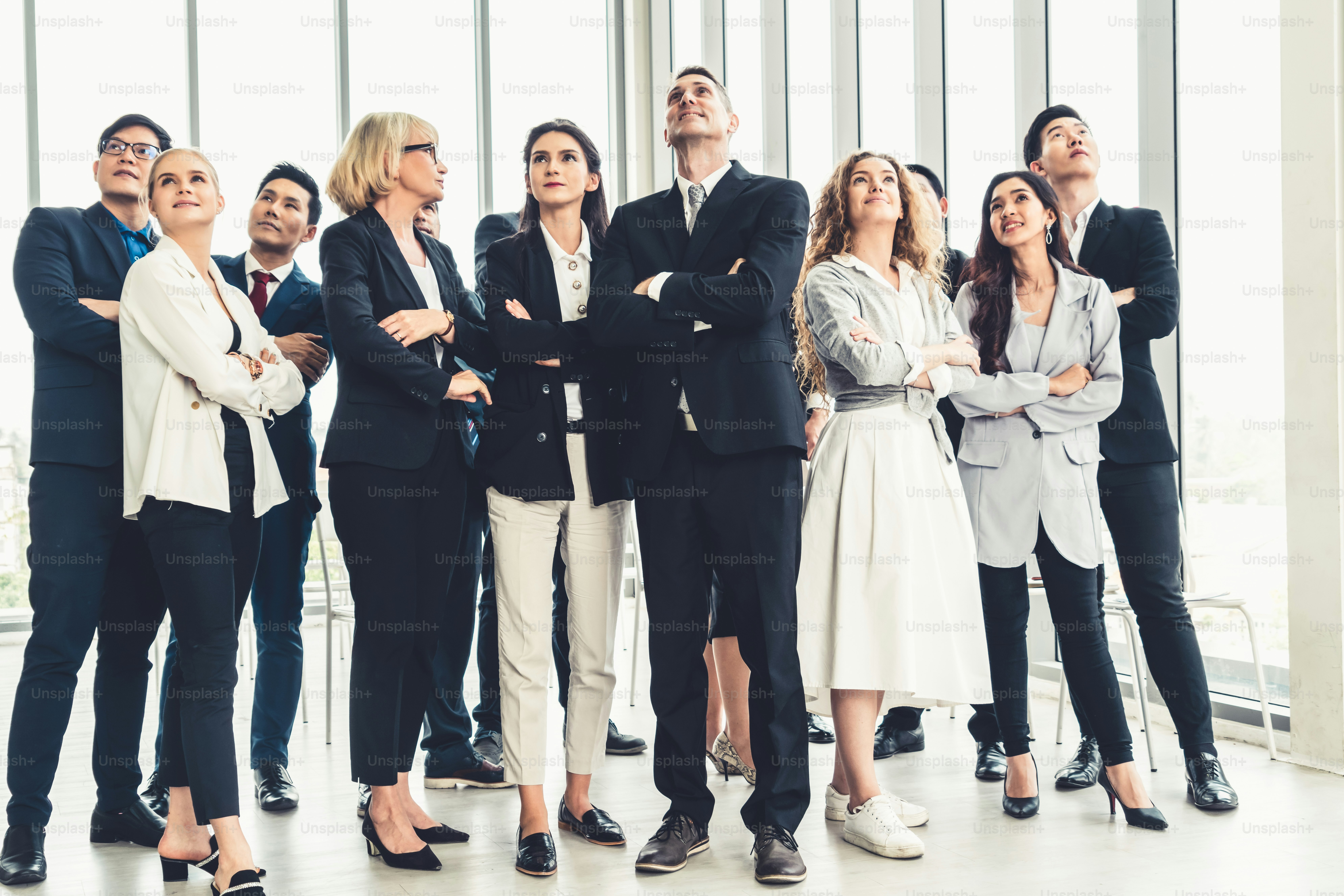 Successful business people standing together showing strong ...