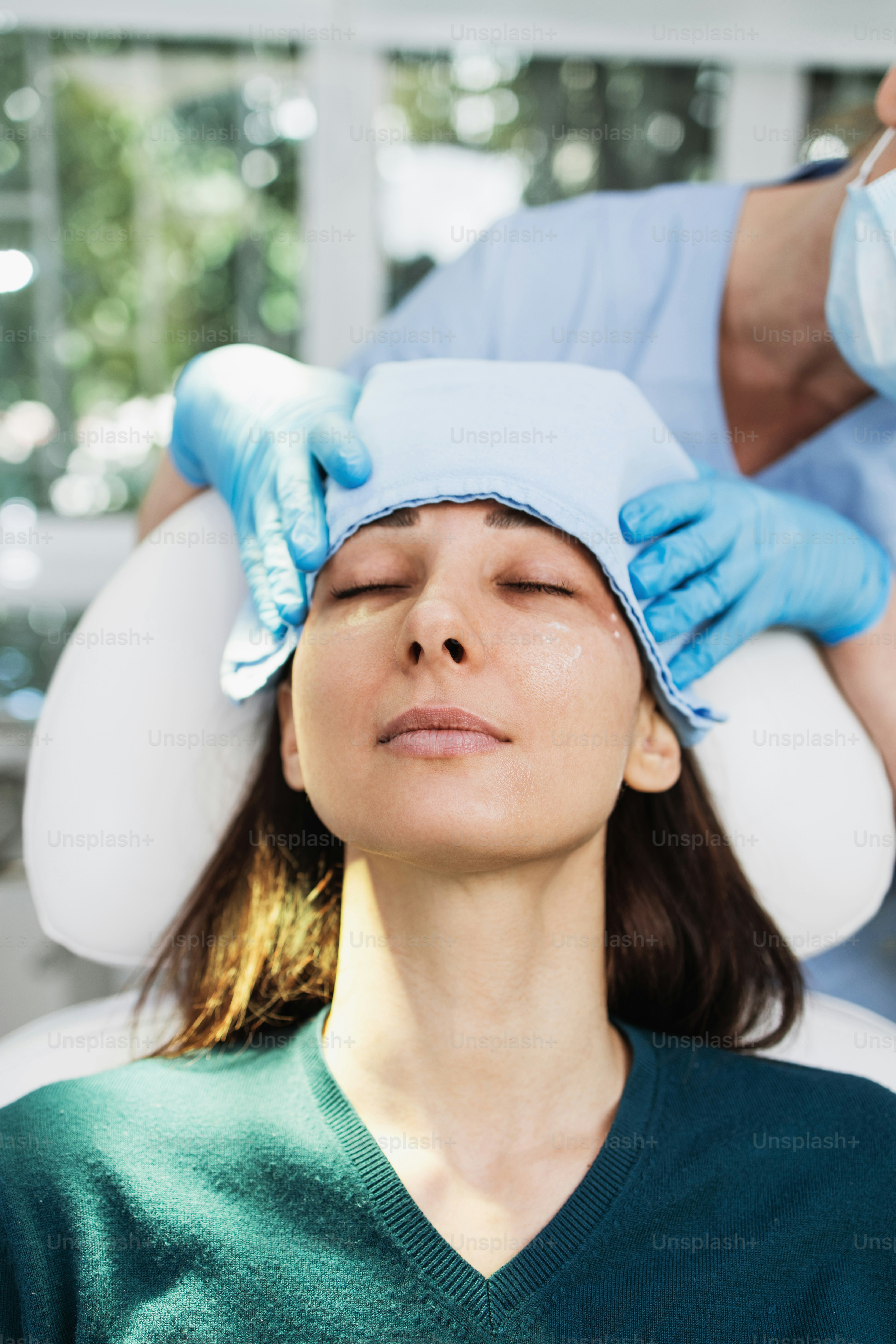 Beautiful and young blonde woman receiving beauty treatment at medical ...