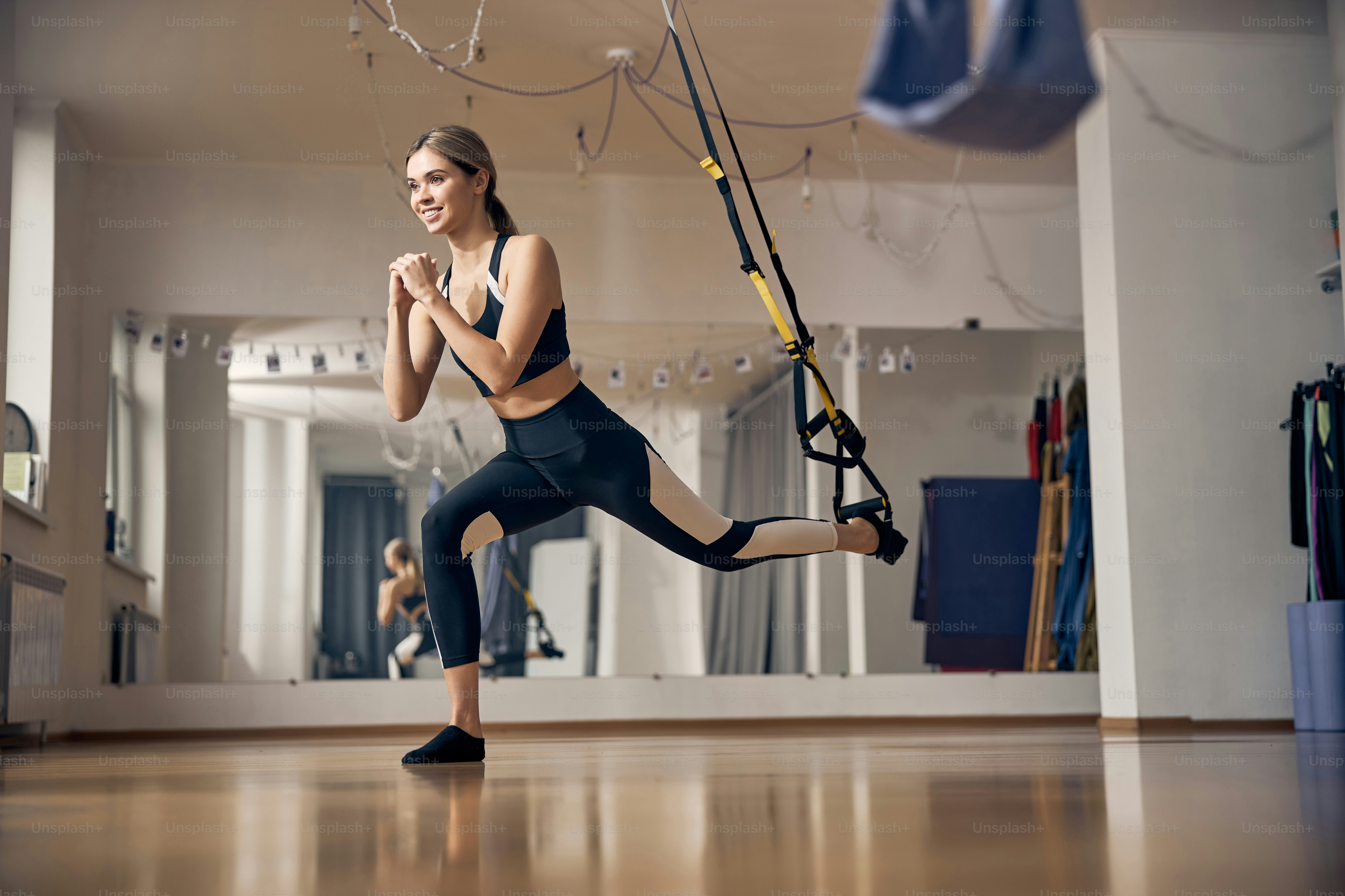 Smiling fit blonde Caucasian female athlete standing with her toes ...
