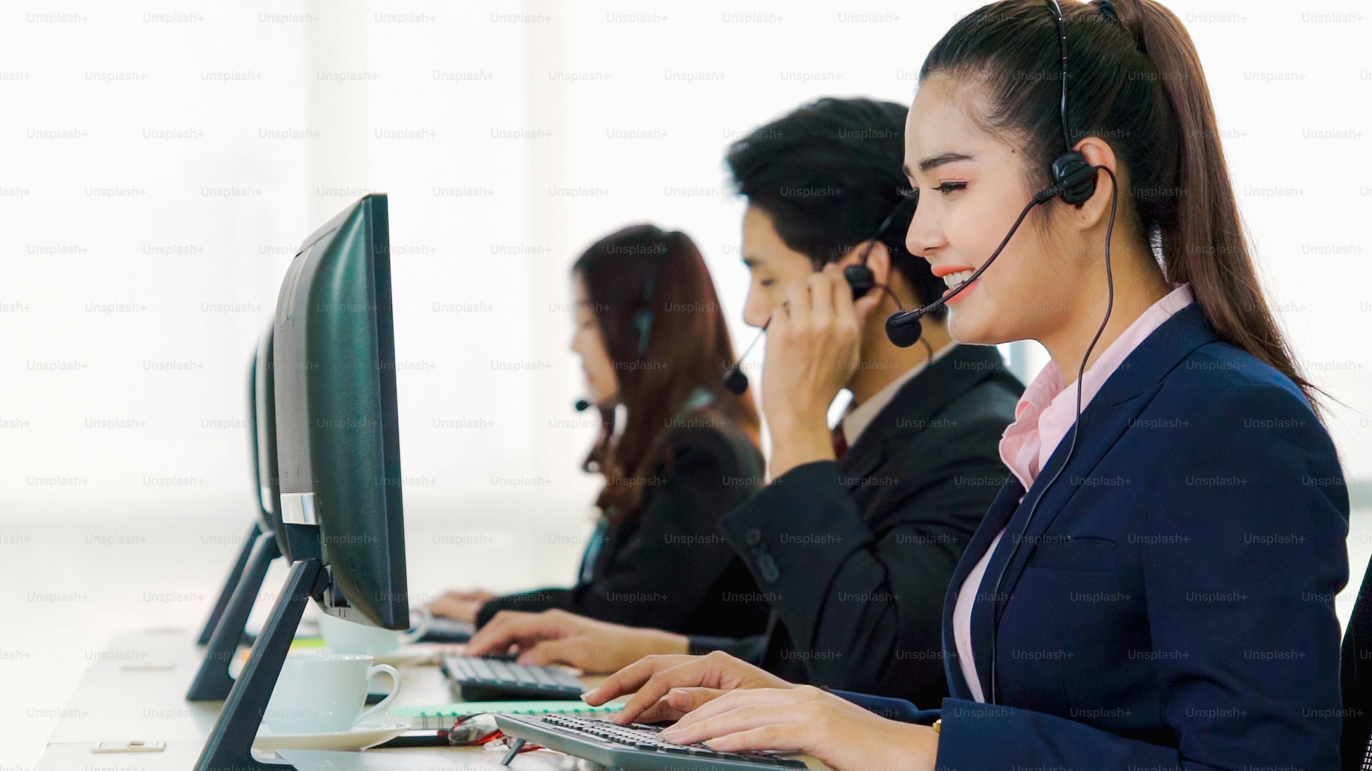 Business people wearing headset working in office to support remote ...