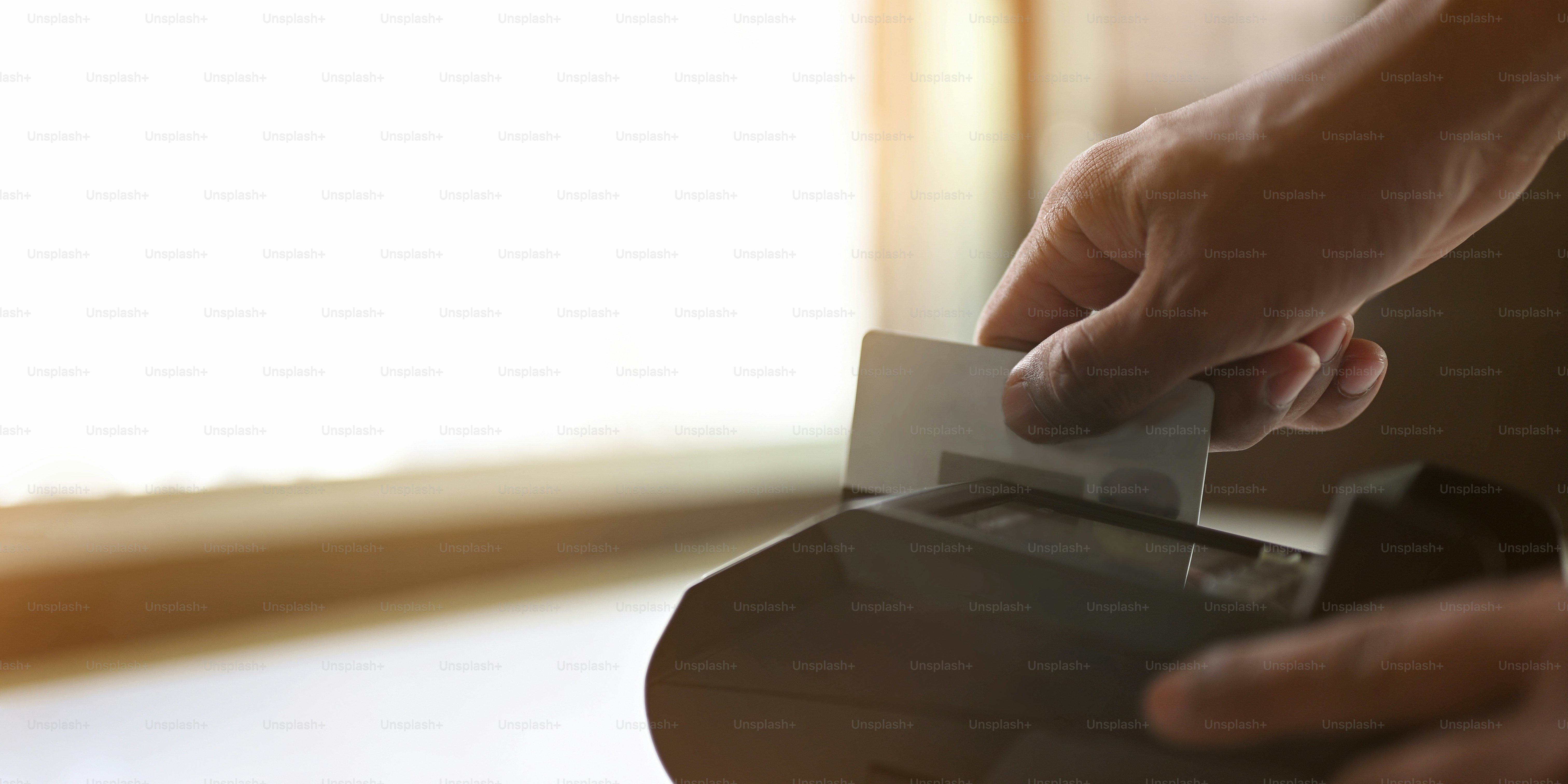 Cropped image of hands swipes a credit card at the card reader. photo ...